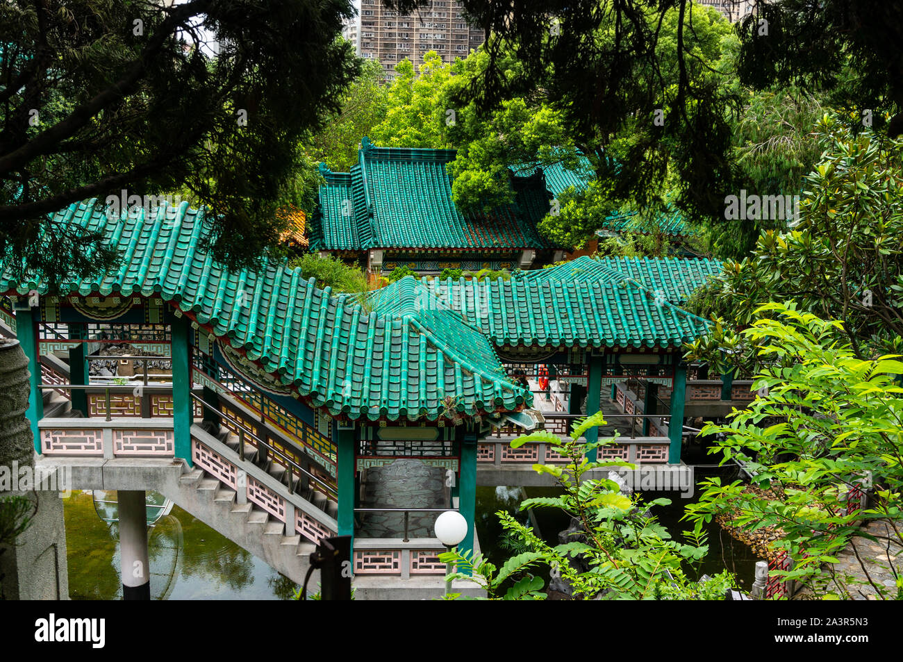 Framed by trees, Chinese temple with green slate roof Stock Photo - Alamy