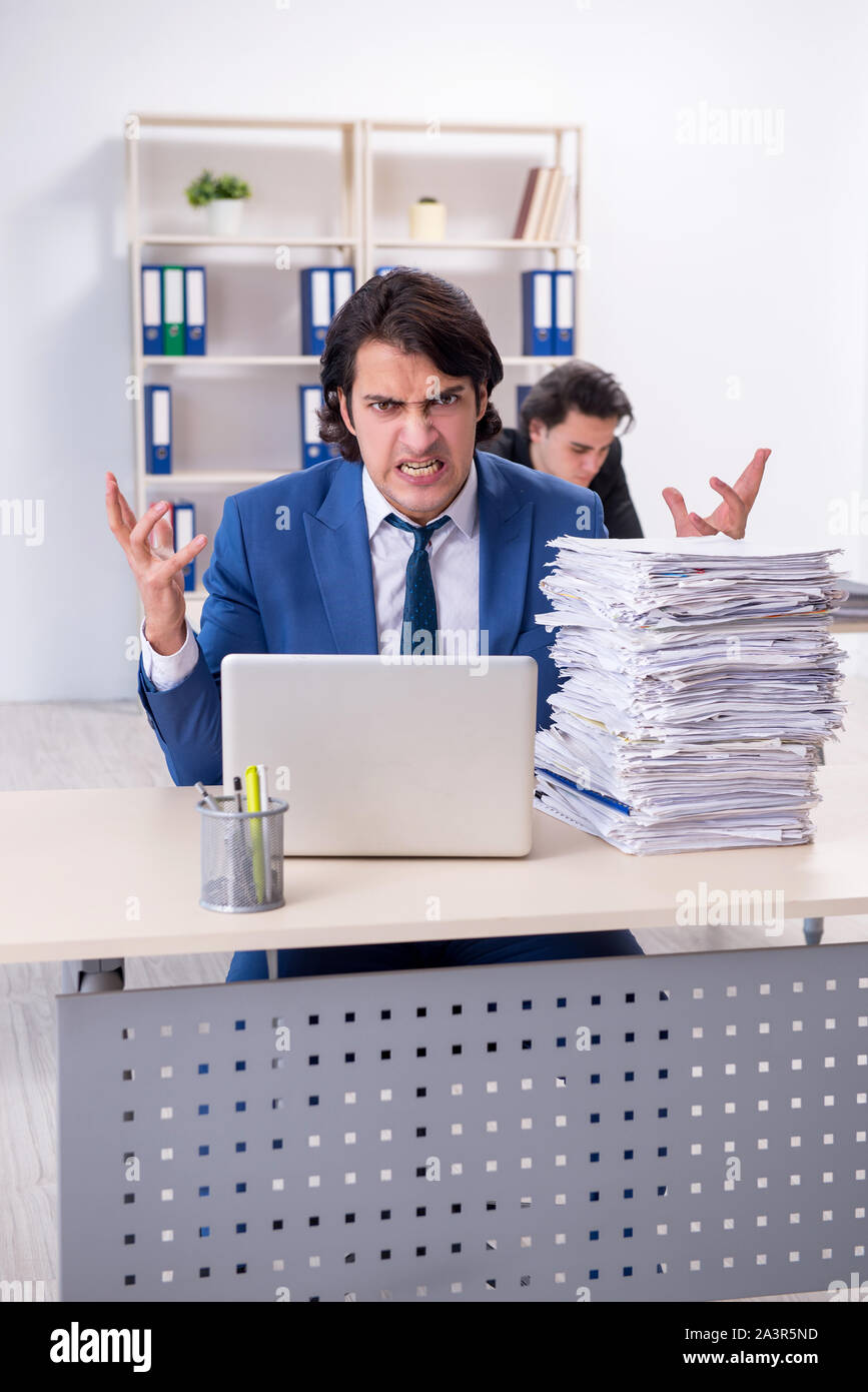 The two male colleagues unhappy with excessive work Stock Photo - Alamy