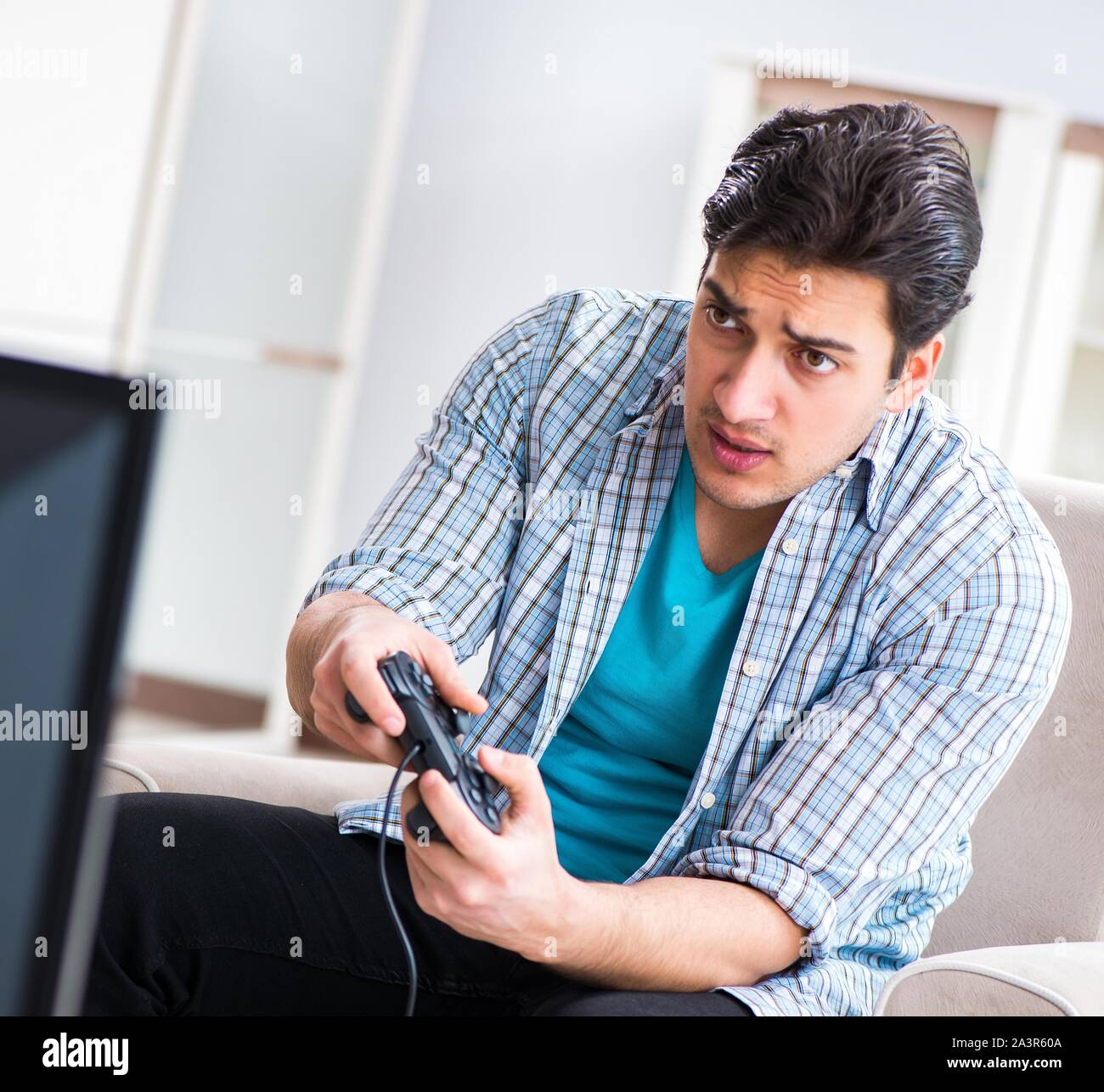 The man playing computer game at home Stock Photo - Alamy