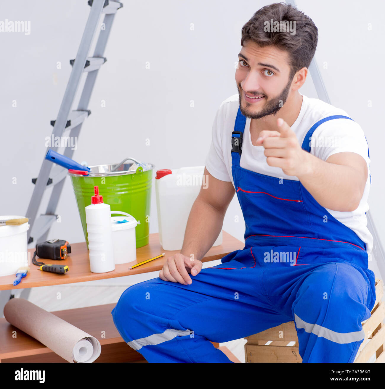 Repairman doing renovation repair in the house with paper wallpaper ...