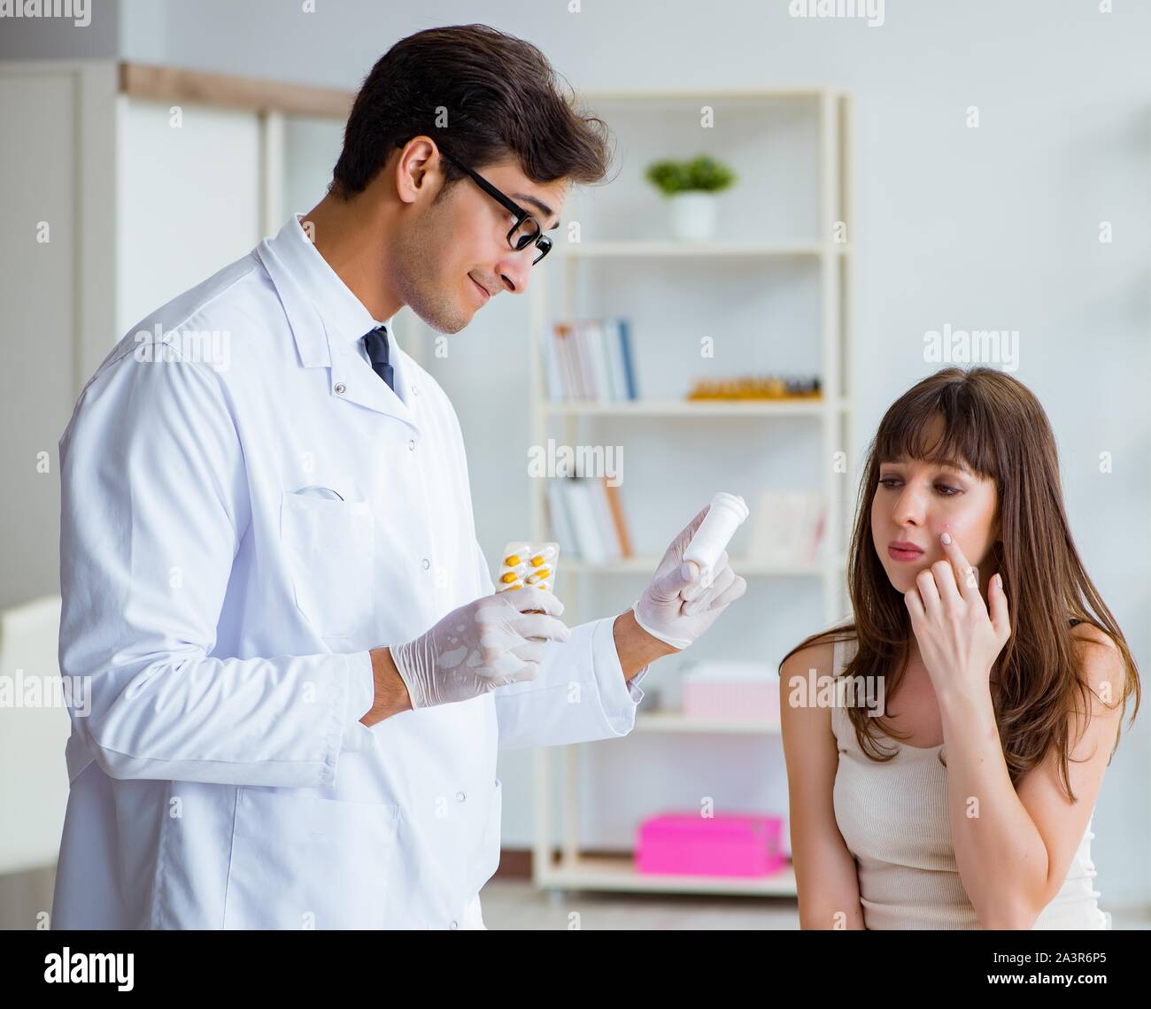 The doctor examining the skin of female patient Stock Photo - Alamy