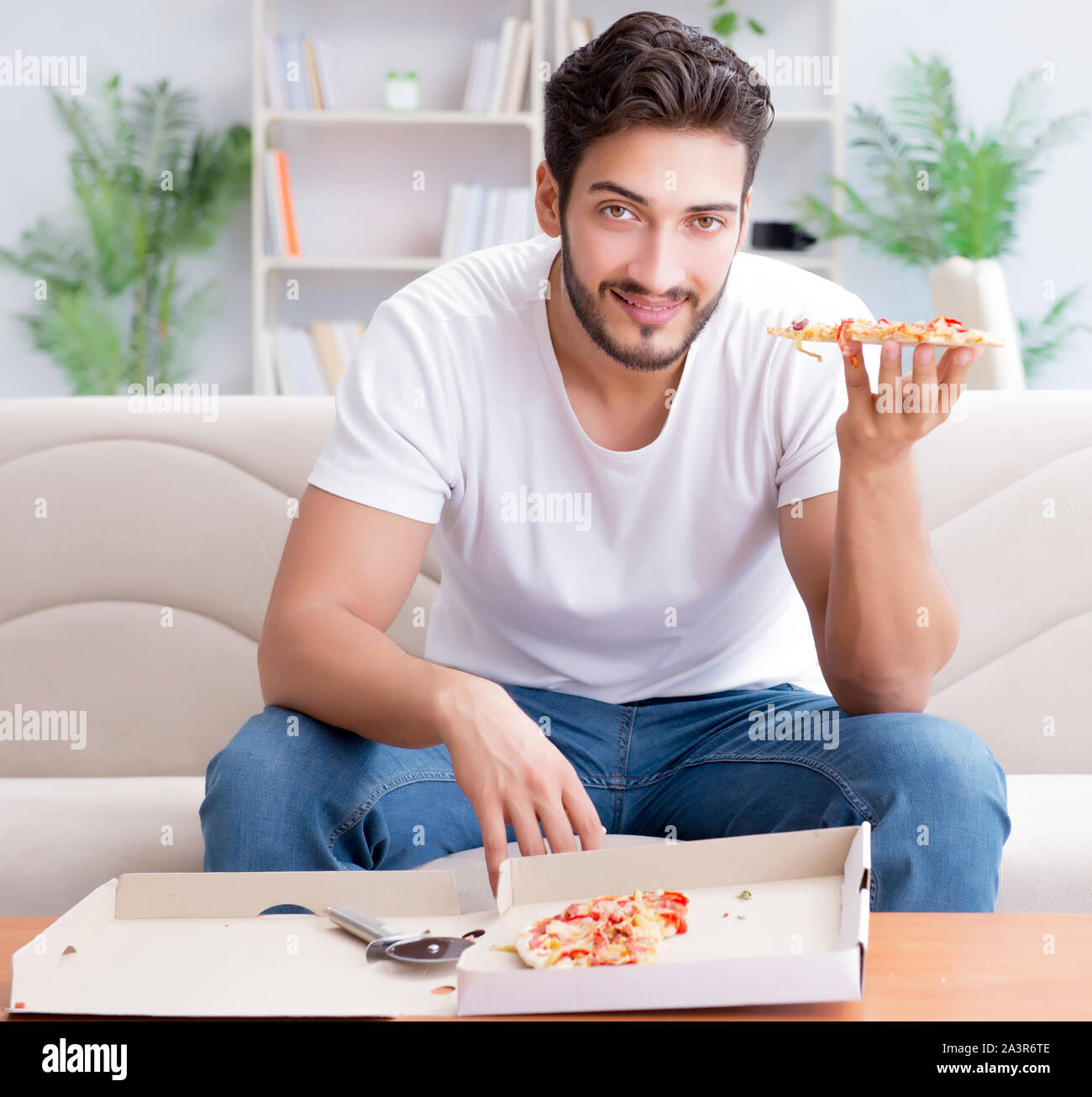 The man eating pizza having a takeaway at home relaxing resting Stock ...