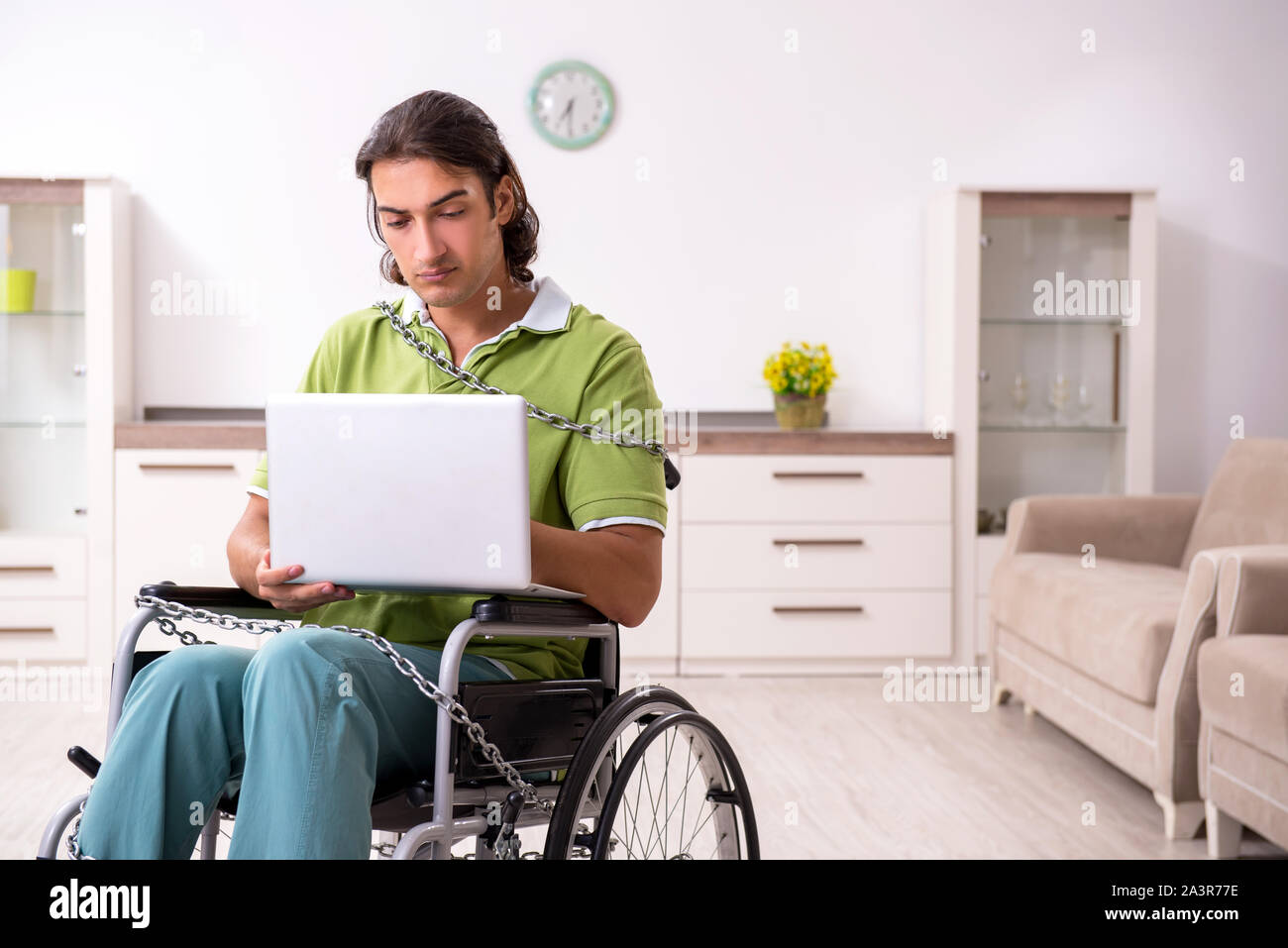 The young male invalid in wheel-chair suffering at home Stock Photo - Alamy