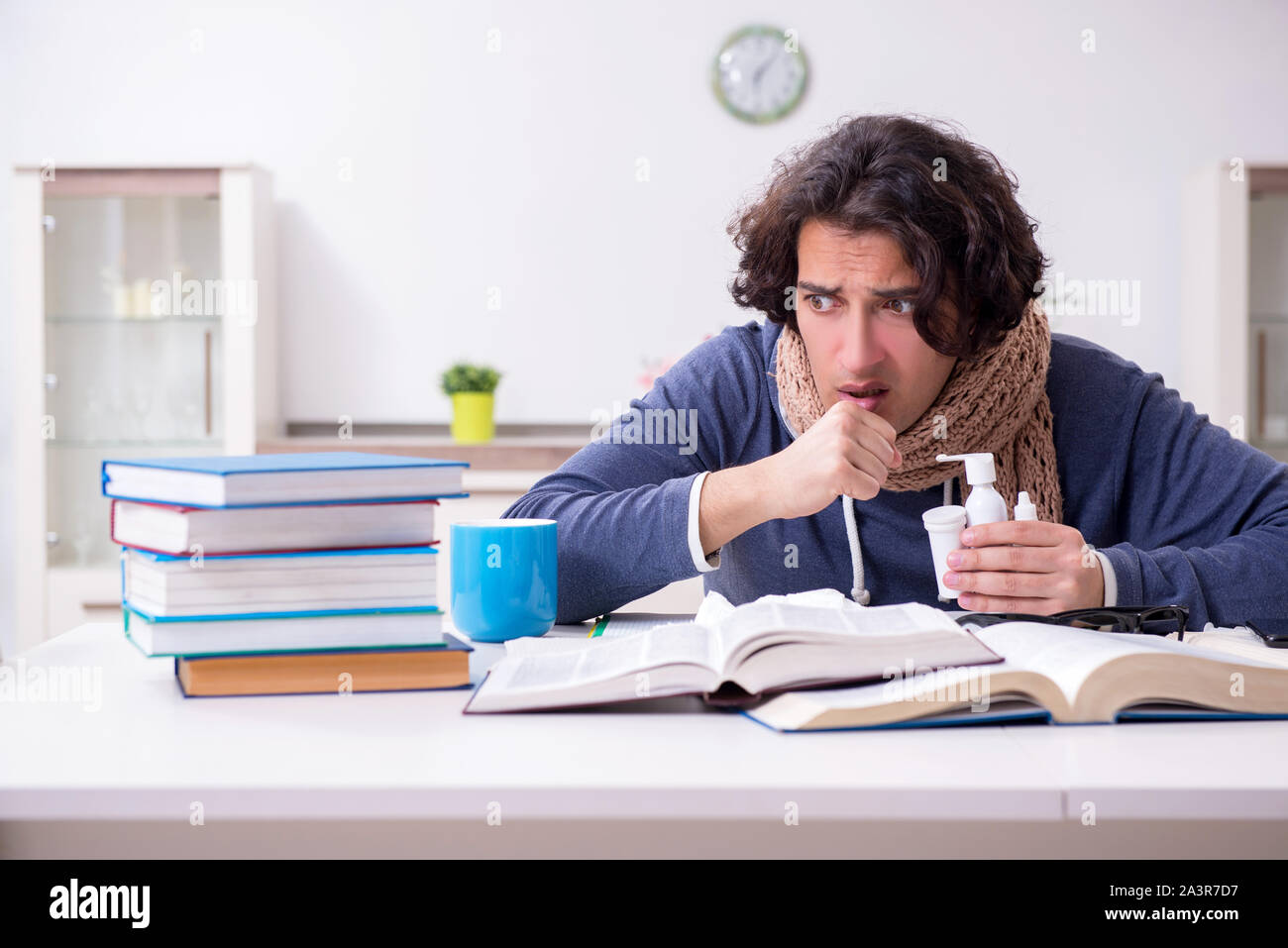 The sick male student suffering at home Stock Photo - Alamy
