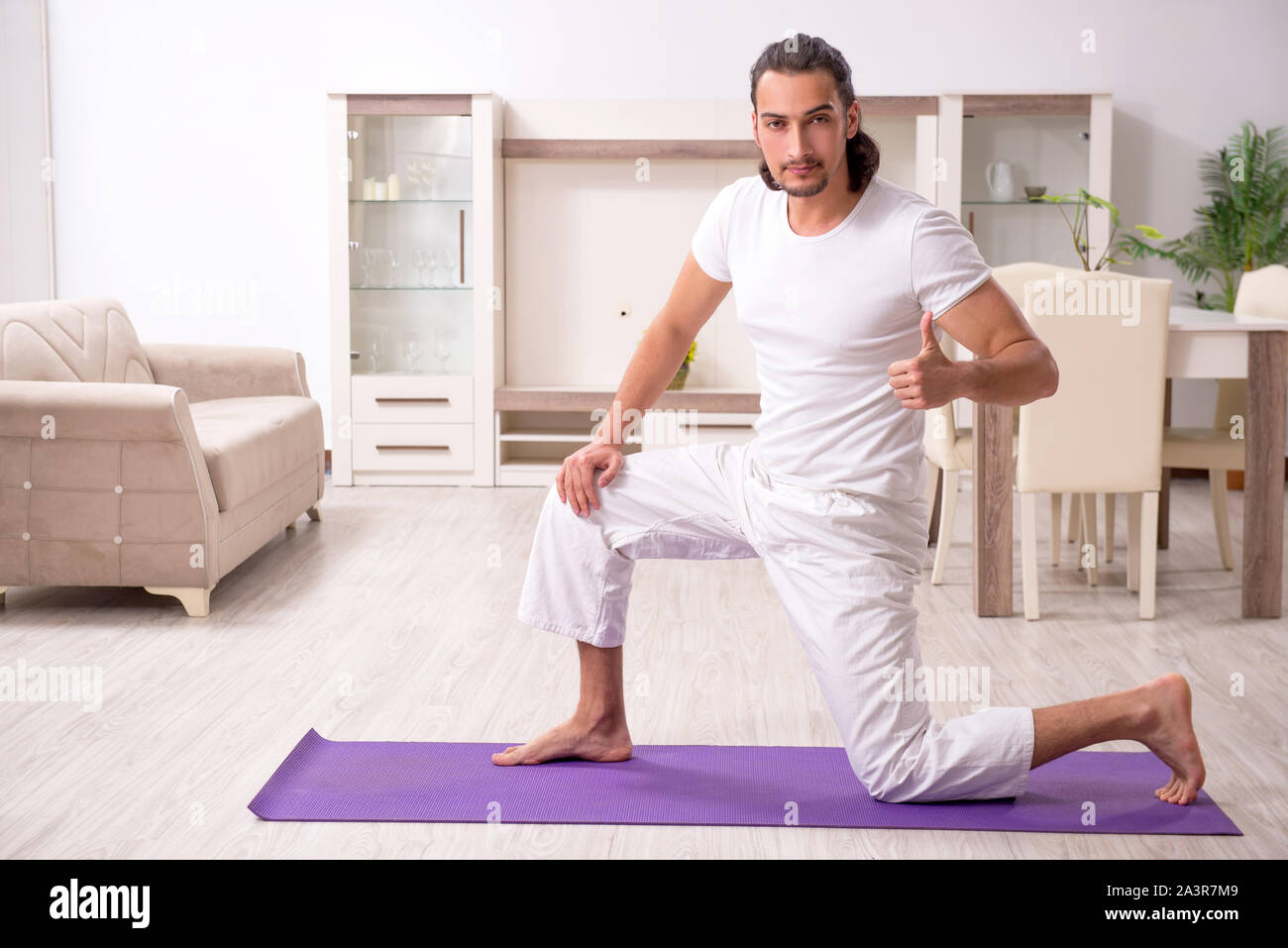 The young man doing physical exercises at home Stock Photo - Alamy