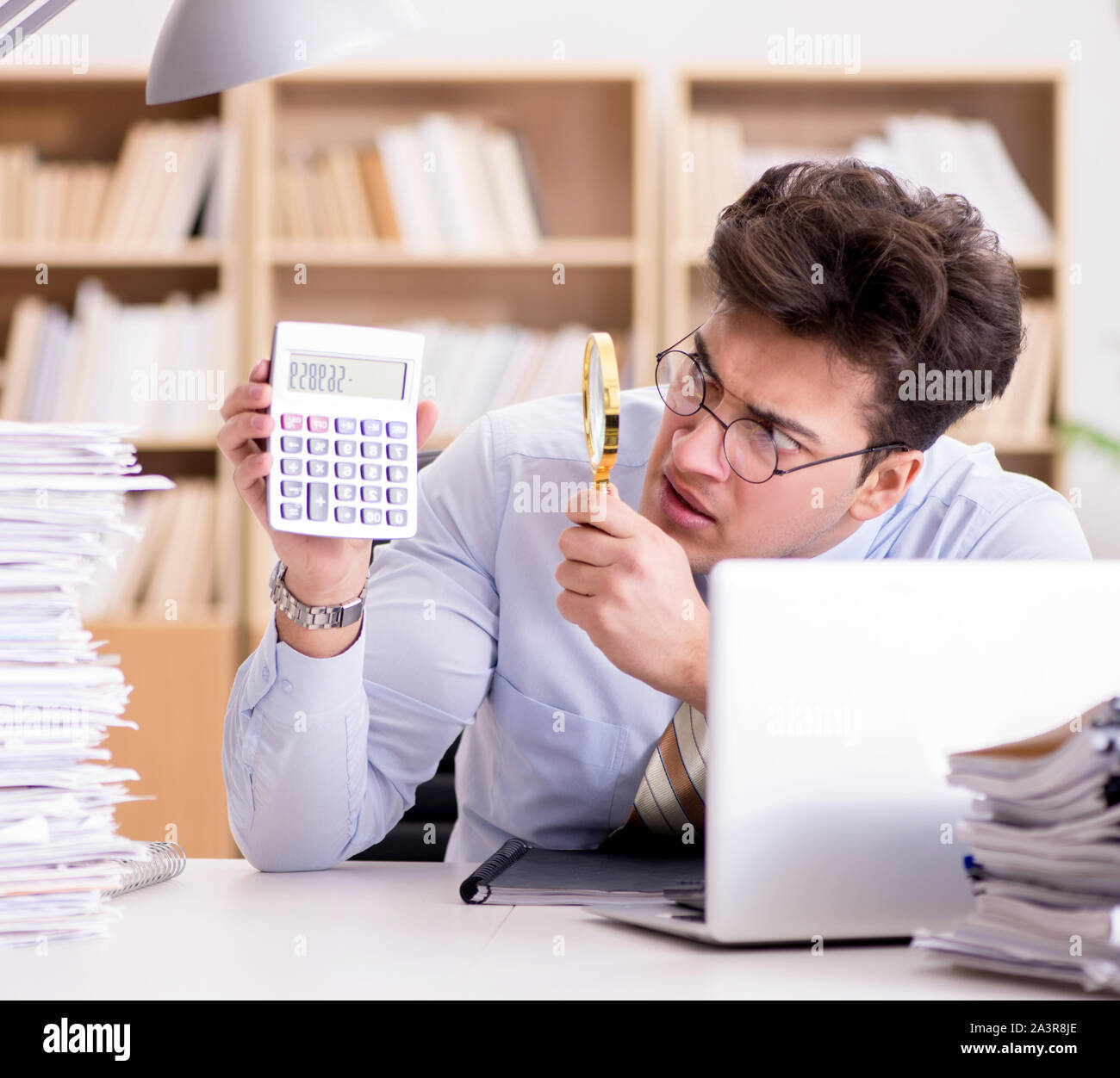 The mad auditor looking for errors in the report Stock Photo - Alamy