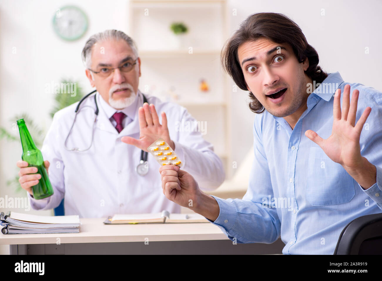 The young male alcoholic visiting old doctor Stock Photo - Alamy