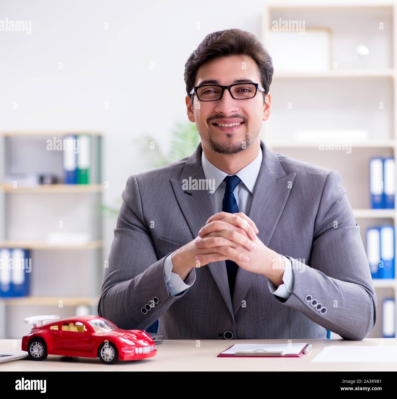 The agent offering car motor insurance Stock Photo - Alamy