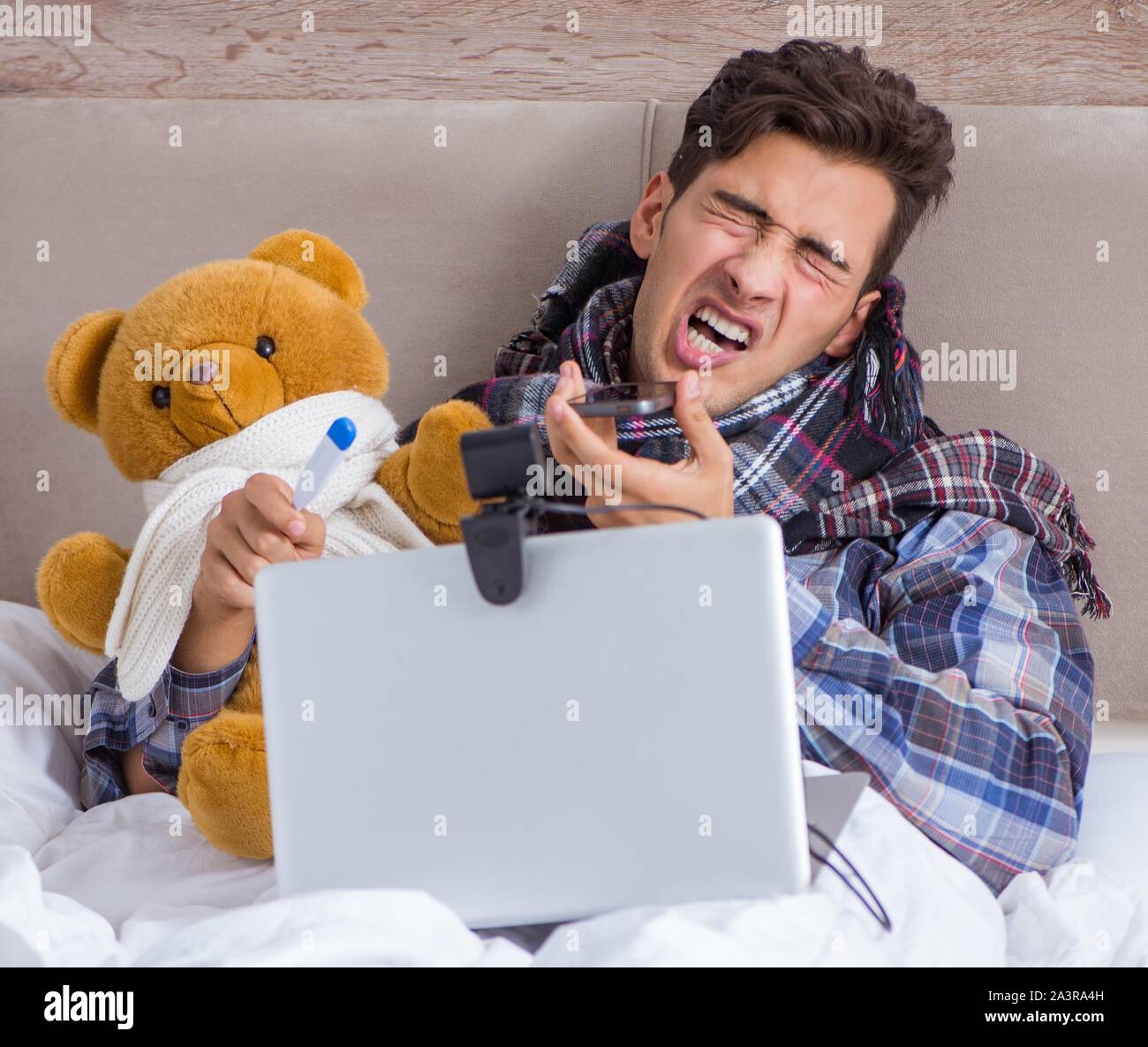 Sick man suffering from flu in the bed Stock Photo - Alamy