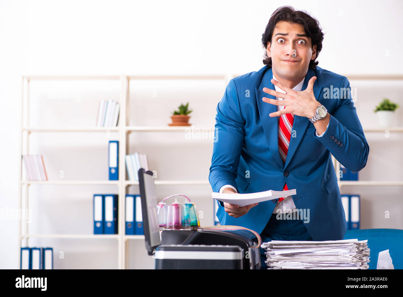 The young employee making copies at copying machine Stock Photo - Alamy