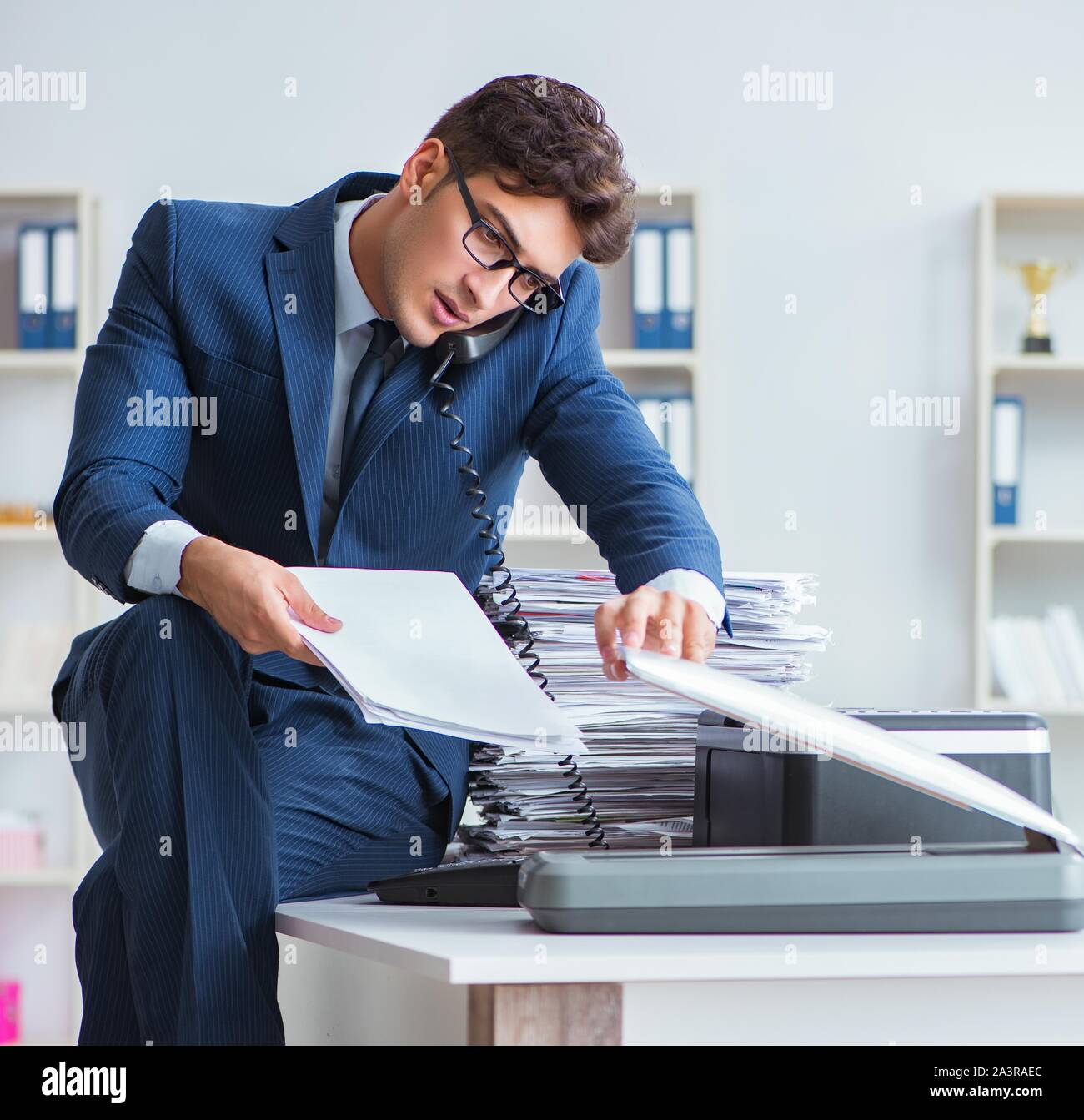 Businessman making copies in copying machine Stock Photo - Alamy