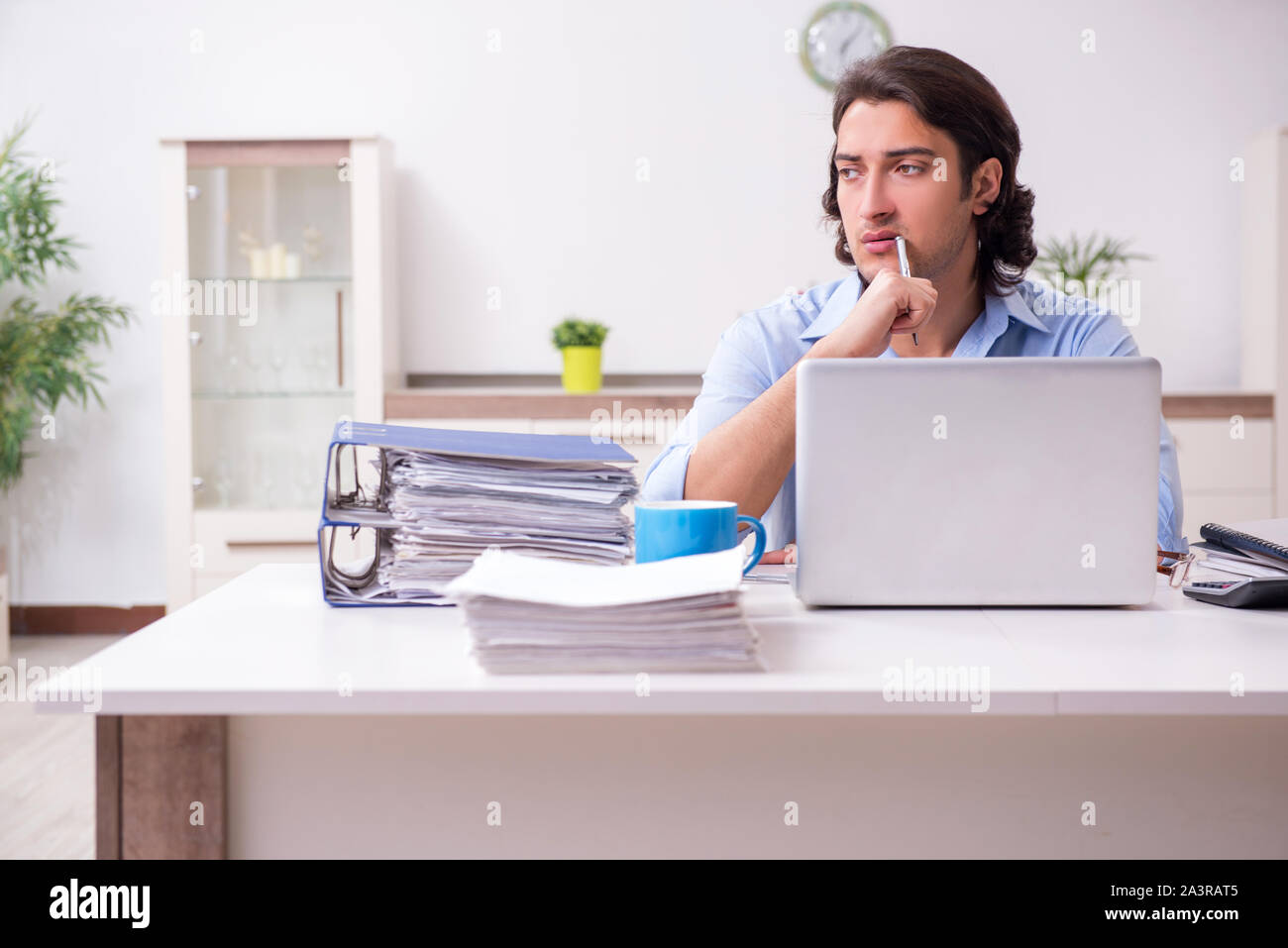 The young male employee working at home Stock Photo - Alamy