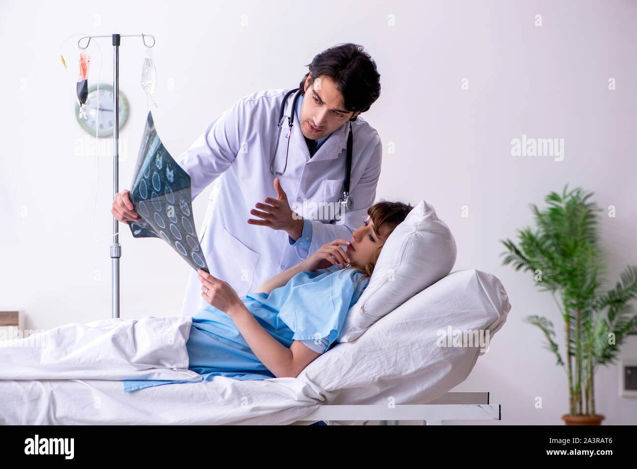 The male doctor visiting female patient in ward Stock Photo - Alamy