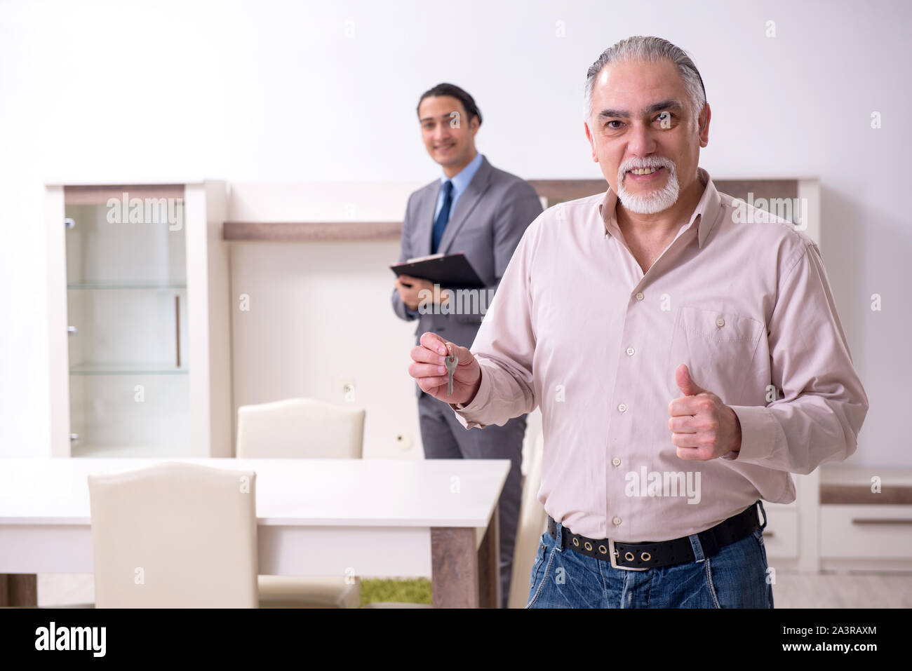 The male real estate agent and male client in the apartment Stock Photo ...