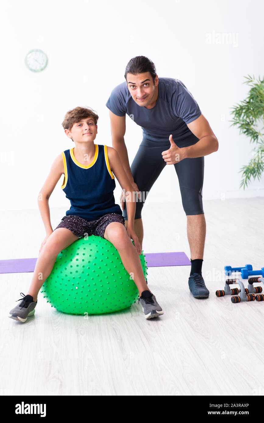The young father and his son doing exercises Stock Photo - Alamy