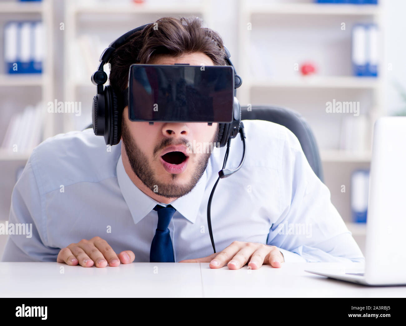 The businessman gamer in office playing games Stock Photo - Alamy