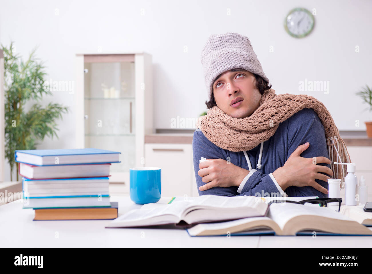 The sick male student suffering at home Stock Photo - Alamy
