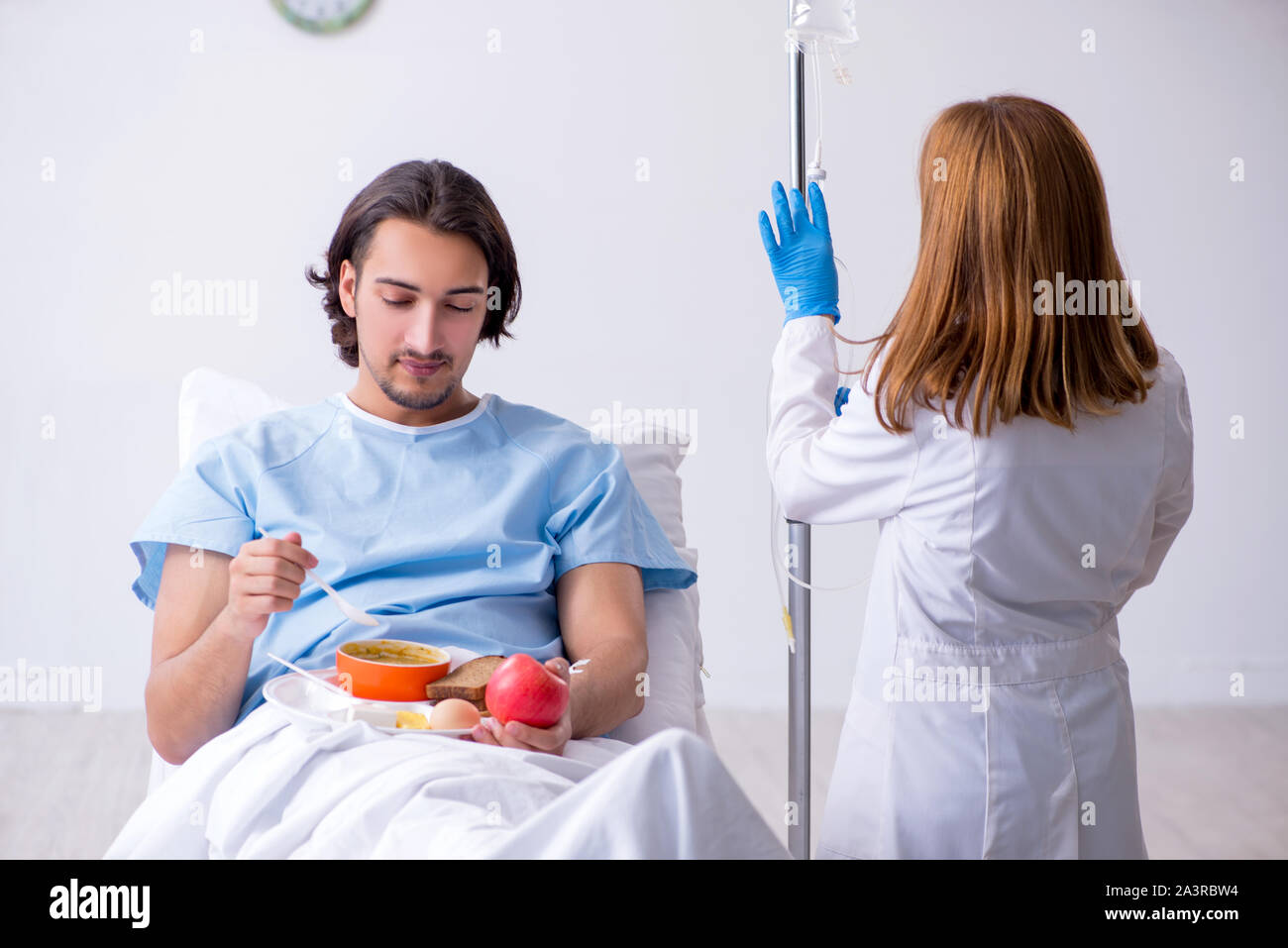 The male patient eating food in the hospital Stock Photo - Alamy
