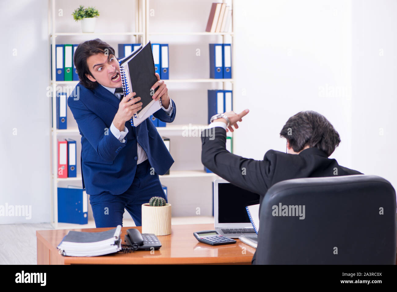 The boss and his male assistant working in the office Stock Photo - Alamy