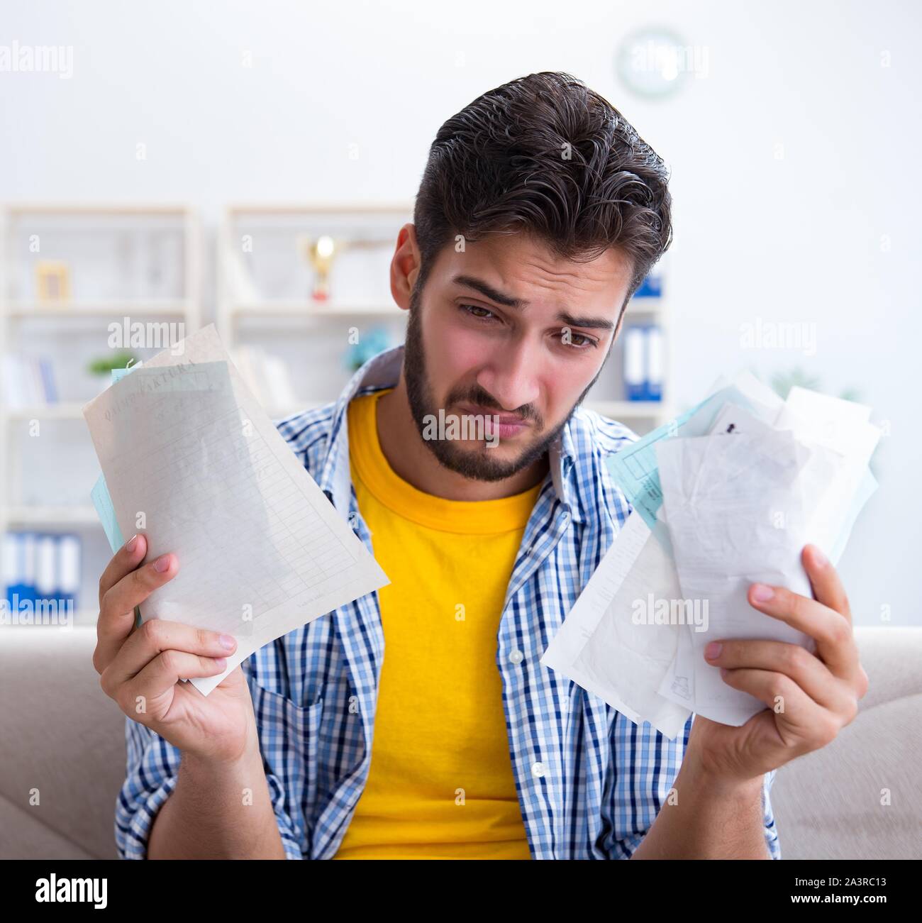 The man angry at bills he needs to pay Stock Photo - Alamy