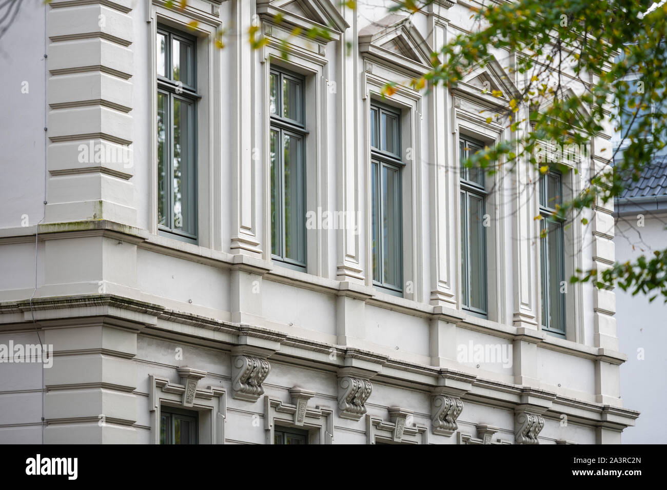 an old white house facade with small windows Stock Photo - Alamy