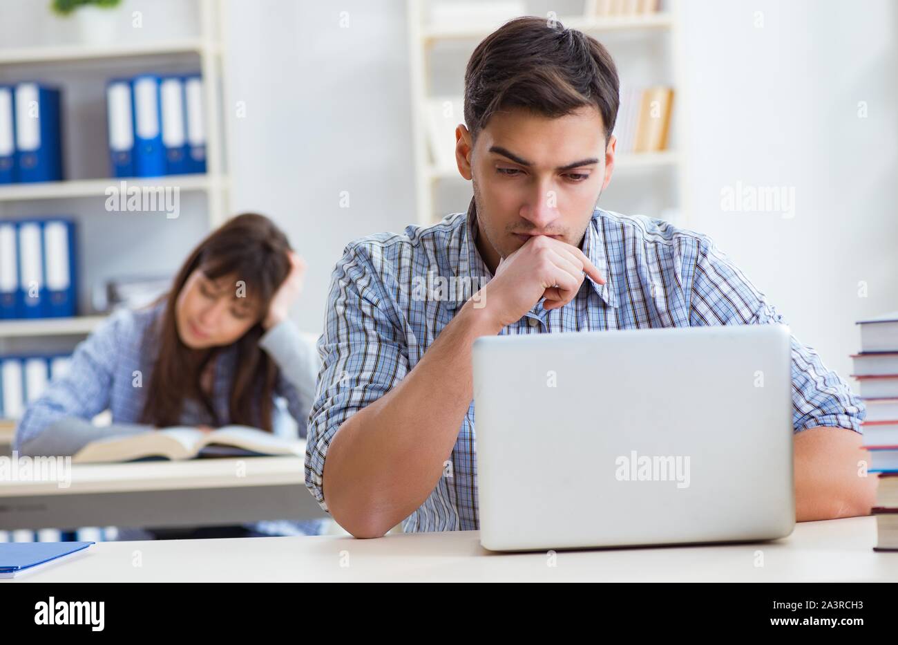 The students sitting and studying in classroom college Stock Photo - Alamy