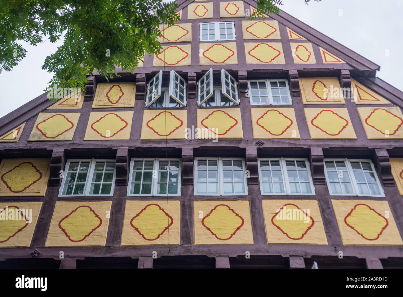 a colorful old house facade with brown and yellow tones Stock Photo - Alamy