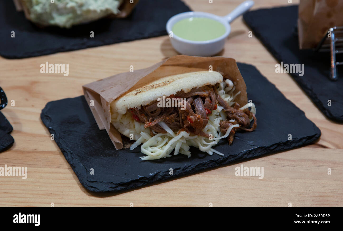 Roasted meat arepa, traditional Latin cuisine on stone plate Stock ...
