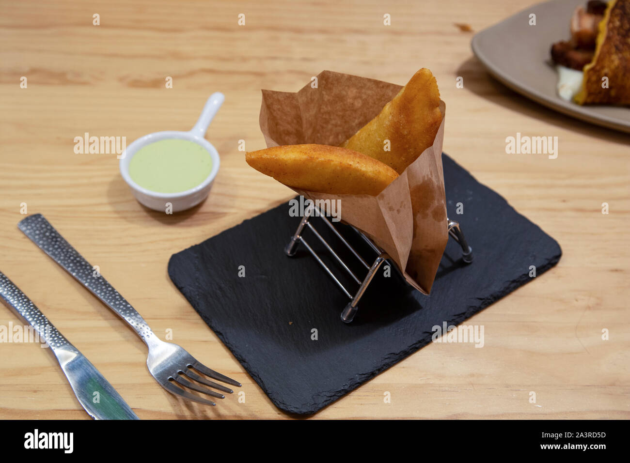 Delicious empanadas typical of Latin cuisine wrapped in paper on stone ...