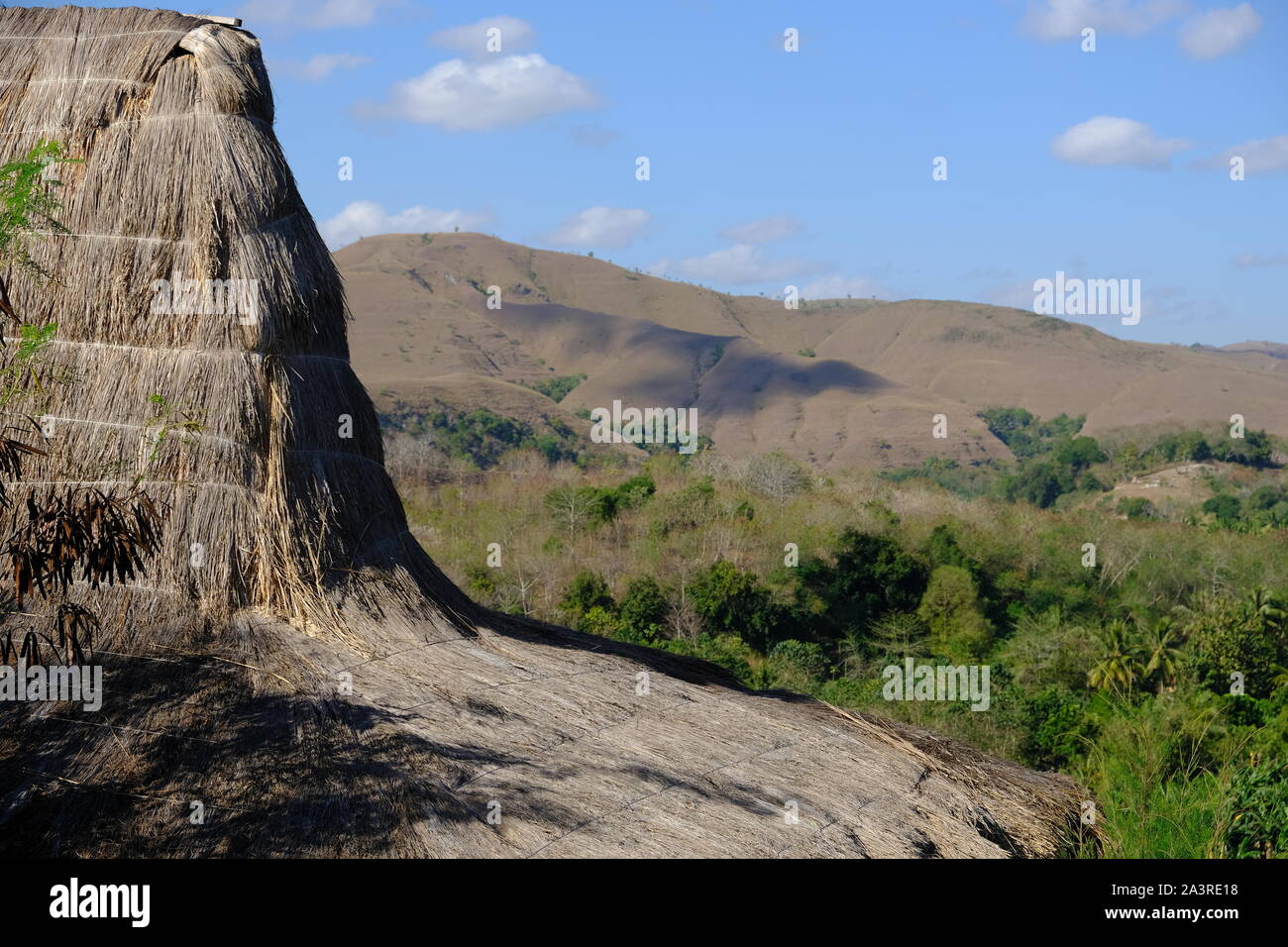 Indonesia Sumba Waingapu peaked roof and landscape with hills in ...