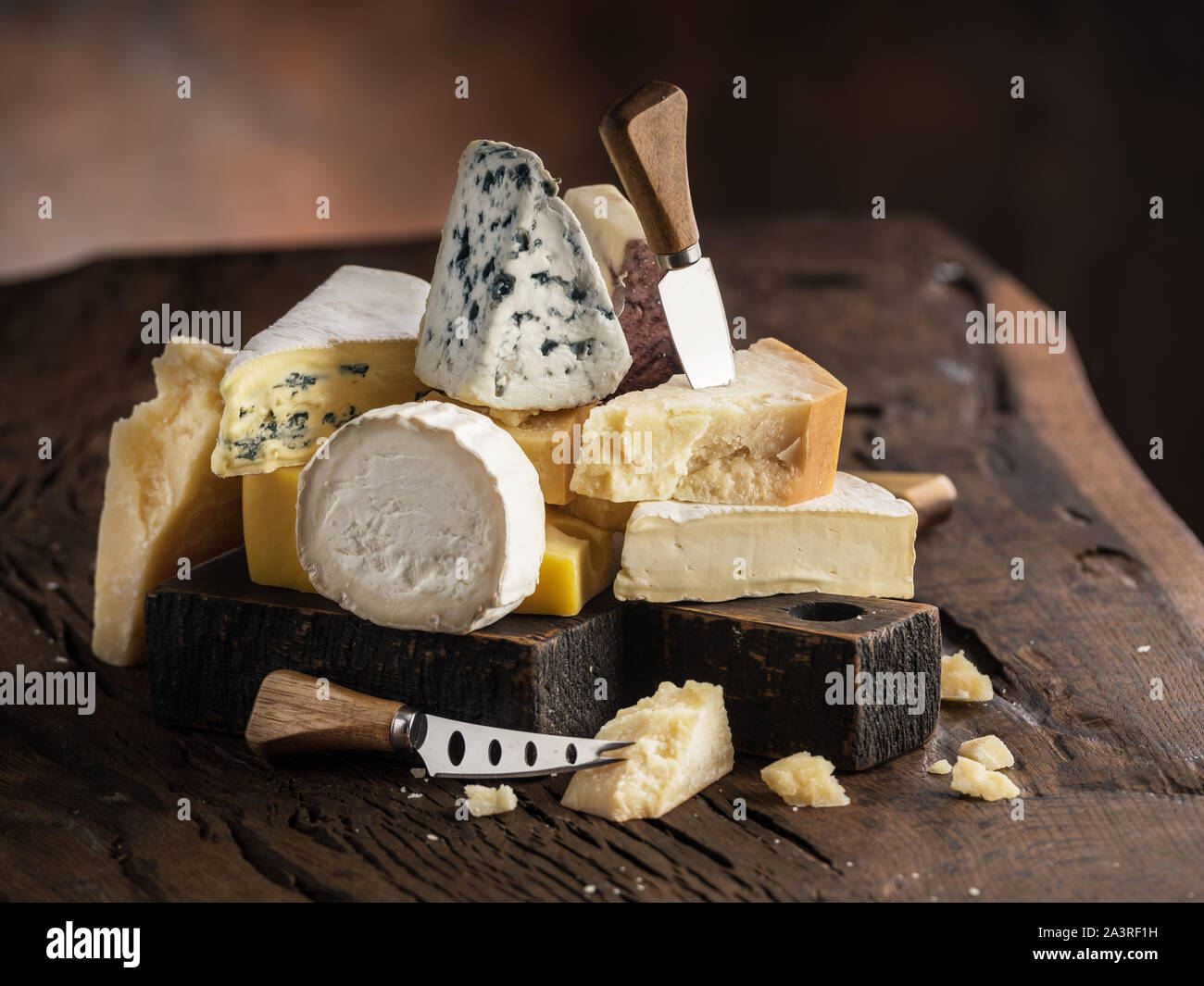 Assortment of different cheese types on wooden background. Cheese ...