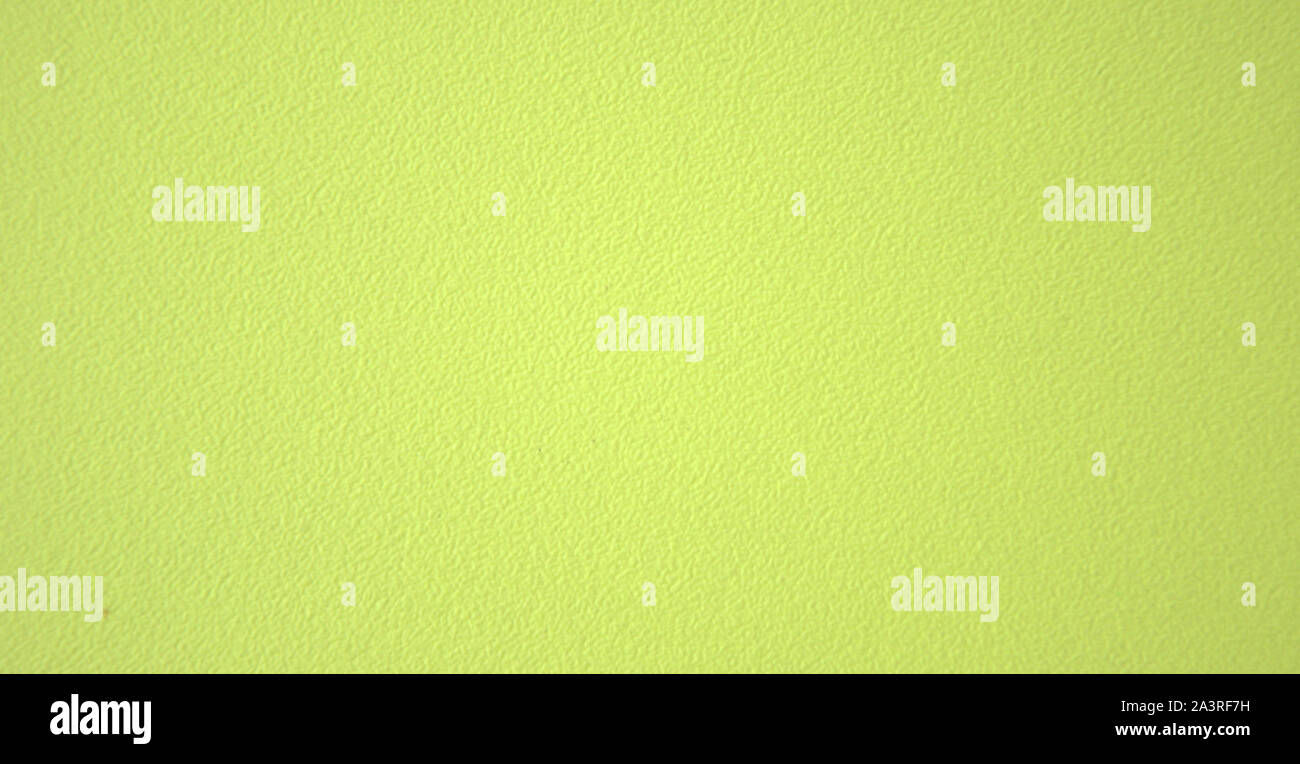 Monochrome background of pale green color with a rough surface close-up ...