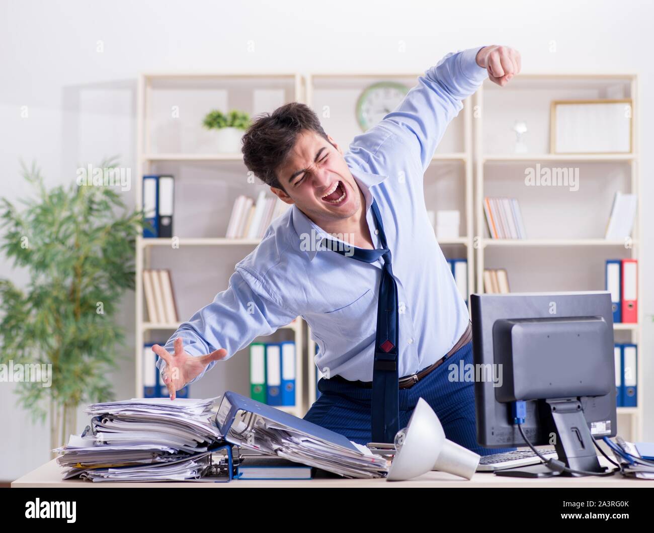 The angry businessman frustrated with too much work Stock Photo - Alamy