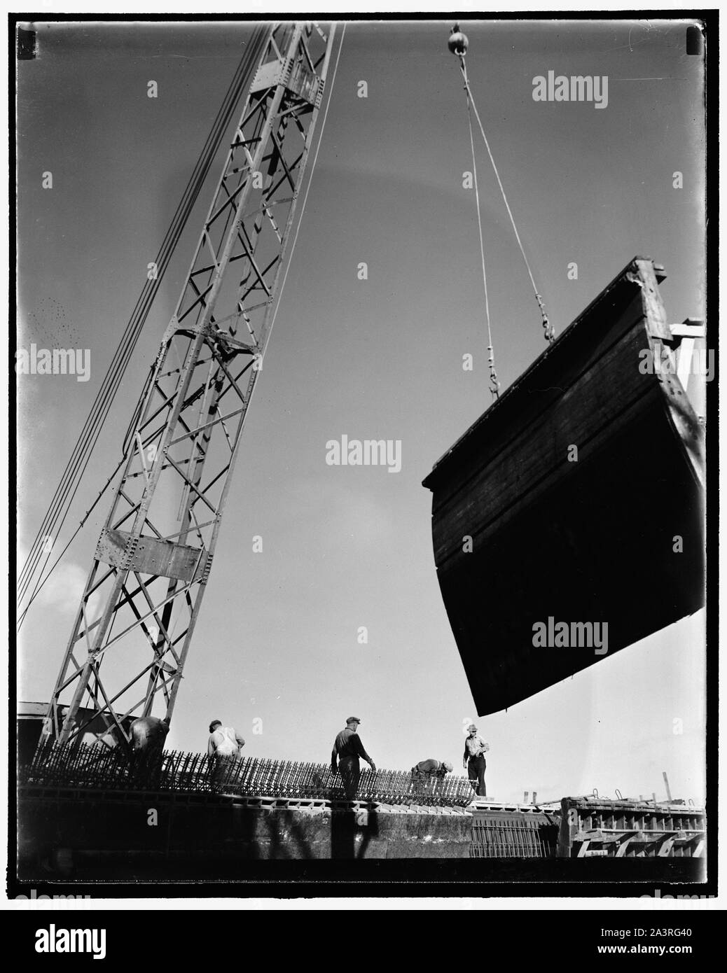 Swinging a form for the concrete high speed basin into place. The ...