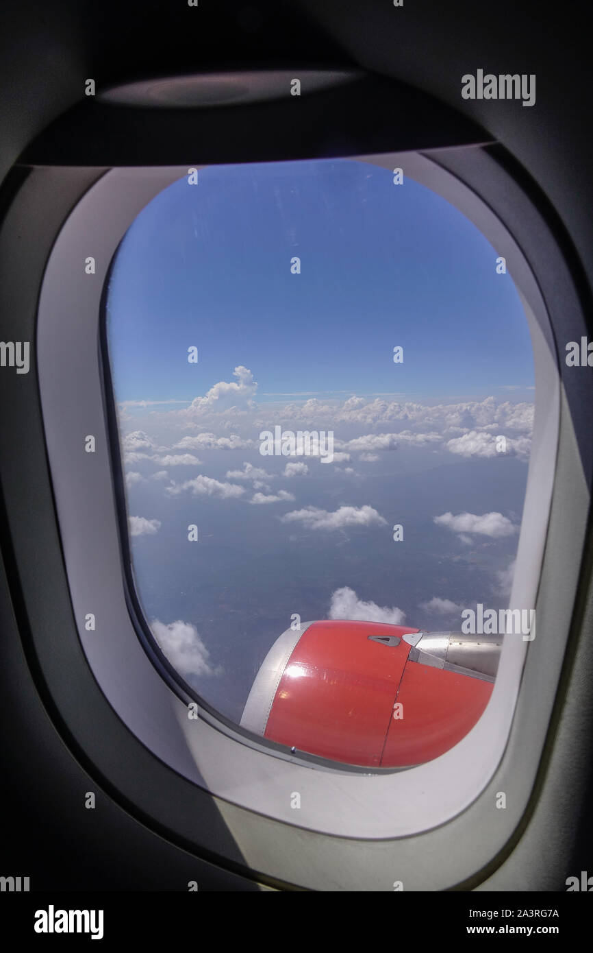 Flying with an airplane, view of the wings, engine, sky and the clouds ...