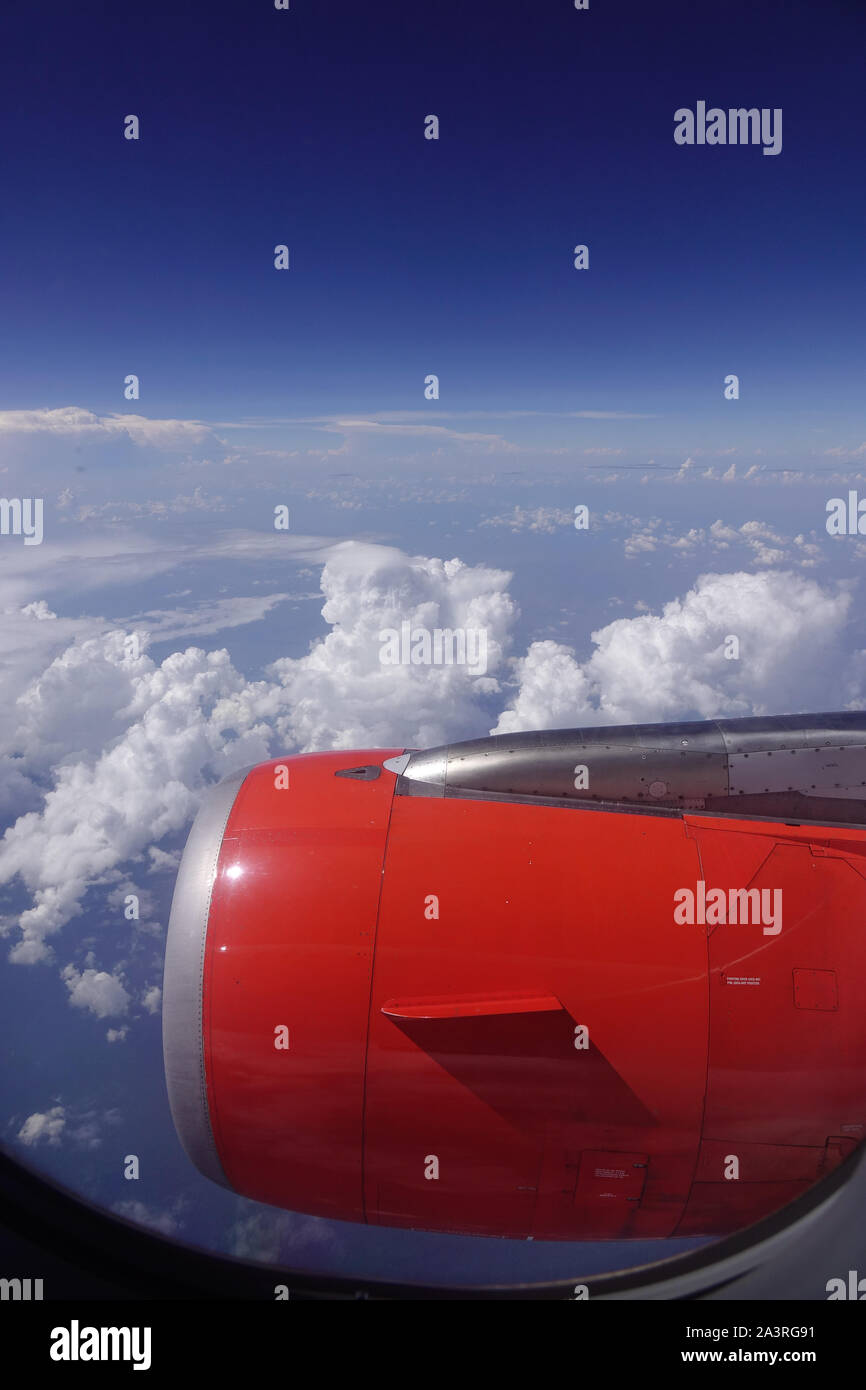 Flying with an airplane, view of the wings, engine, sky and the clouds ...