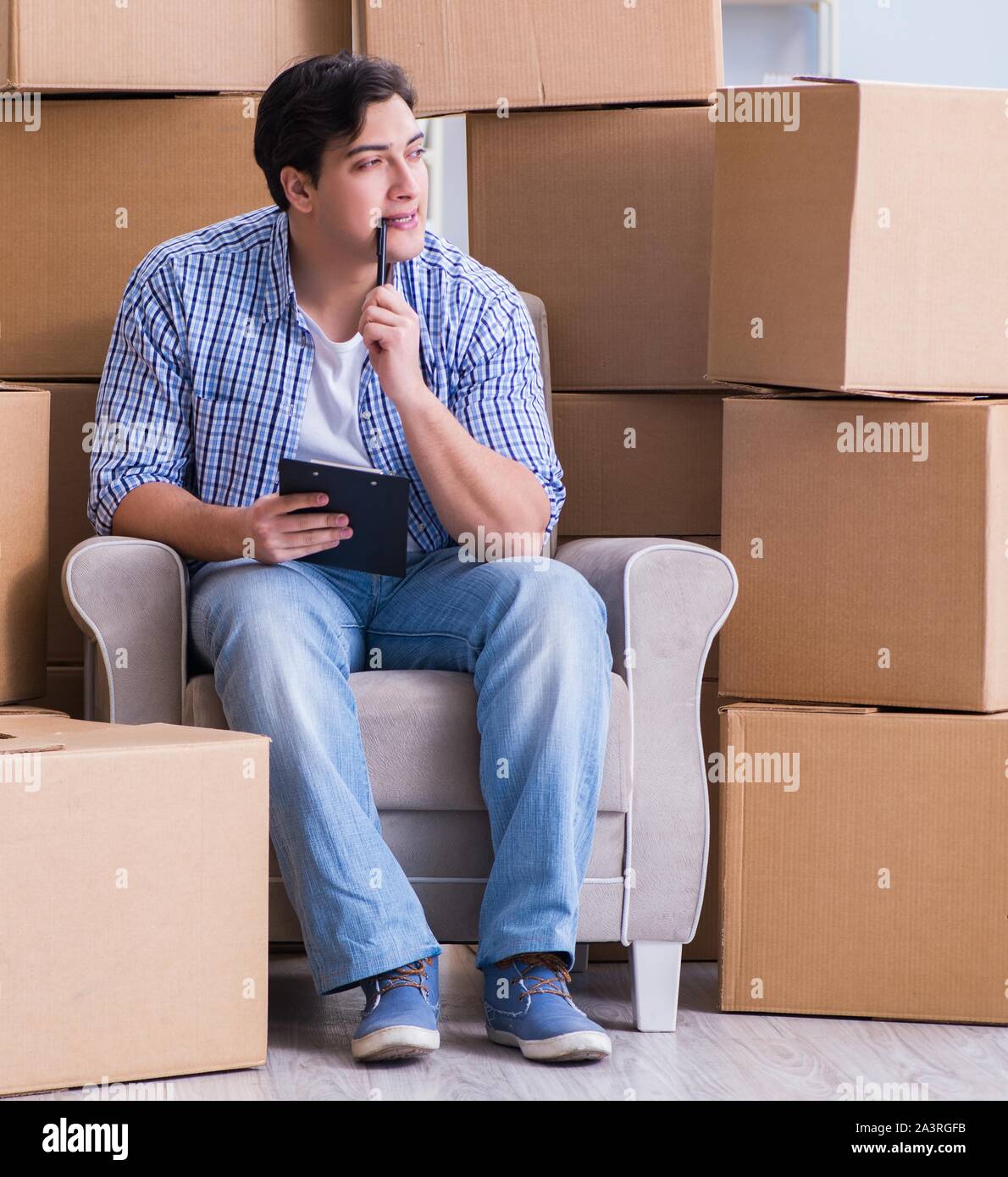 Young man moving in to new house with boxes Stock Photo - Alamy