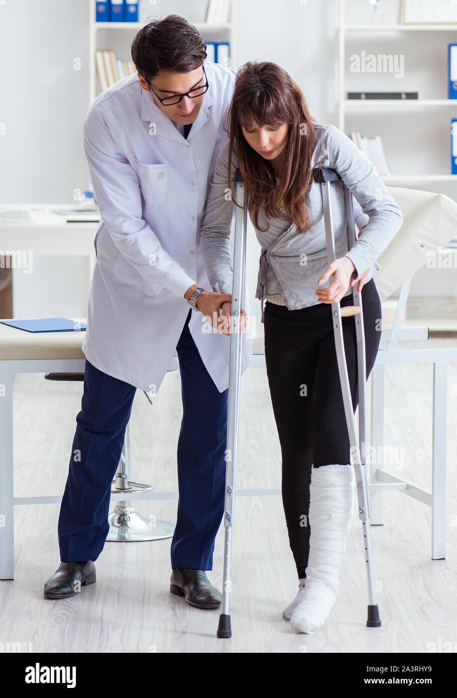 The doctor examining patient with broken leg Stock Photo - Alamy