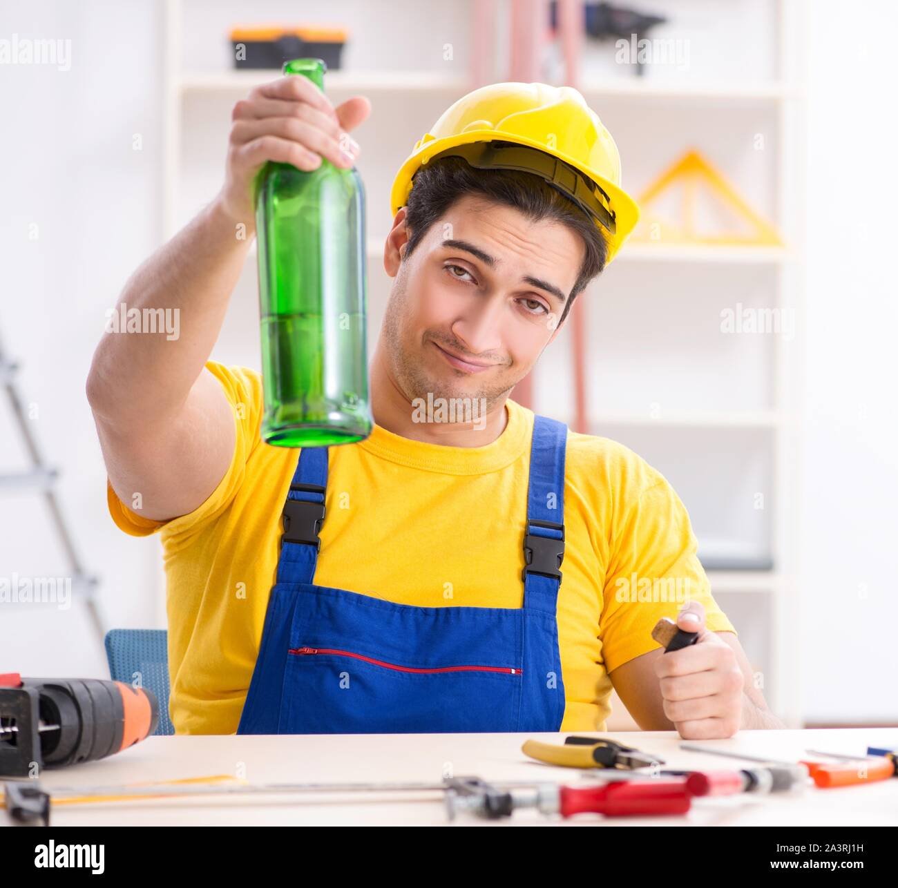 The drunk engineer working in the workshop Stock Photo - Alamy