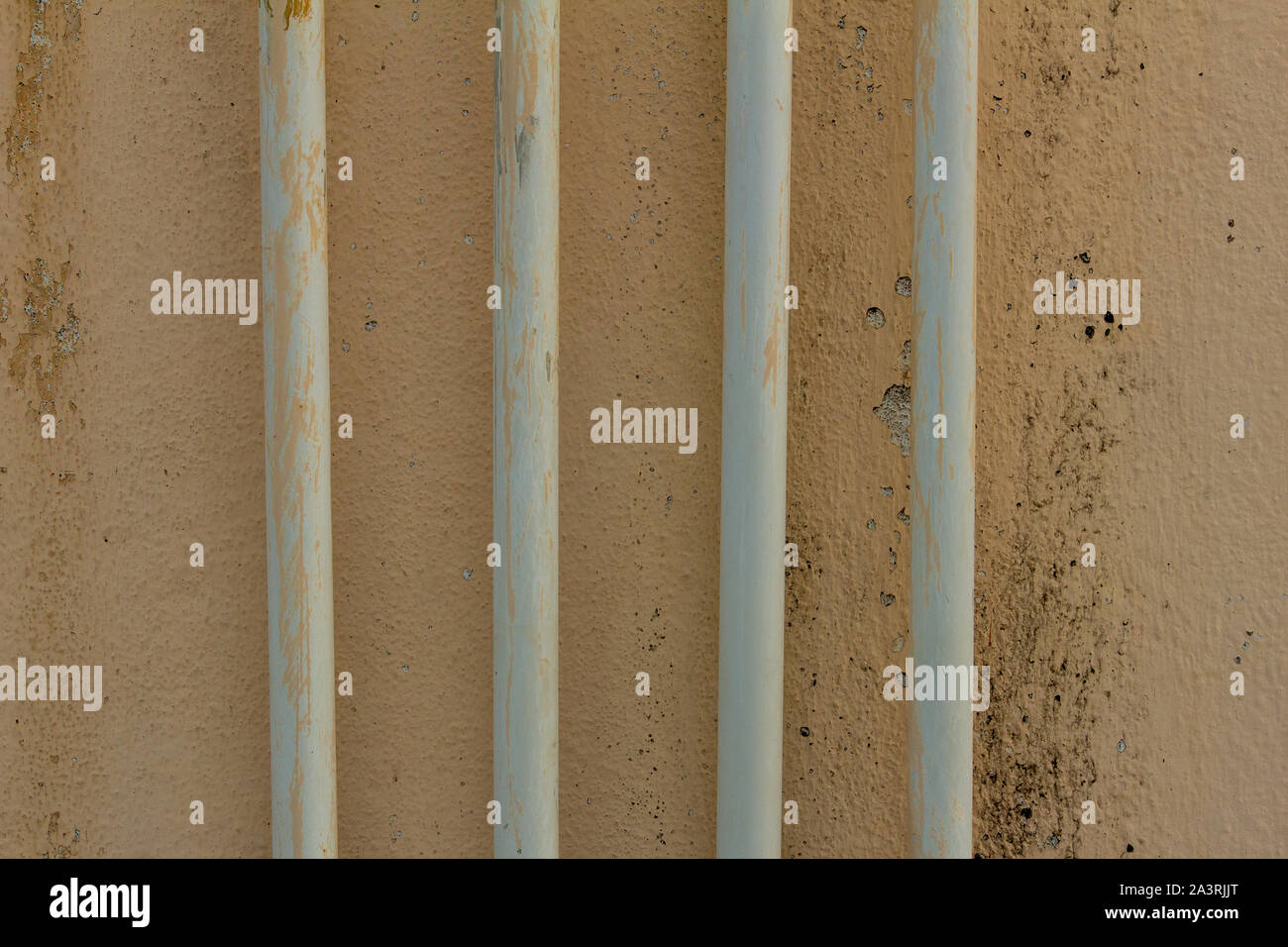 Pipes running along the wall in building exterior Stock Photo - Alamy