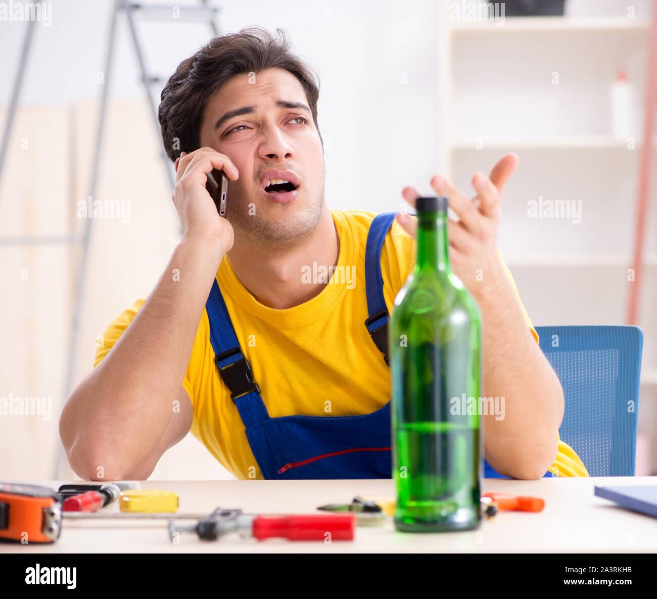 The drunk engineer working in the workshop Stock Photo - Alamy