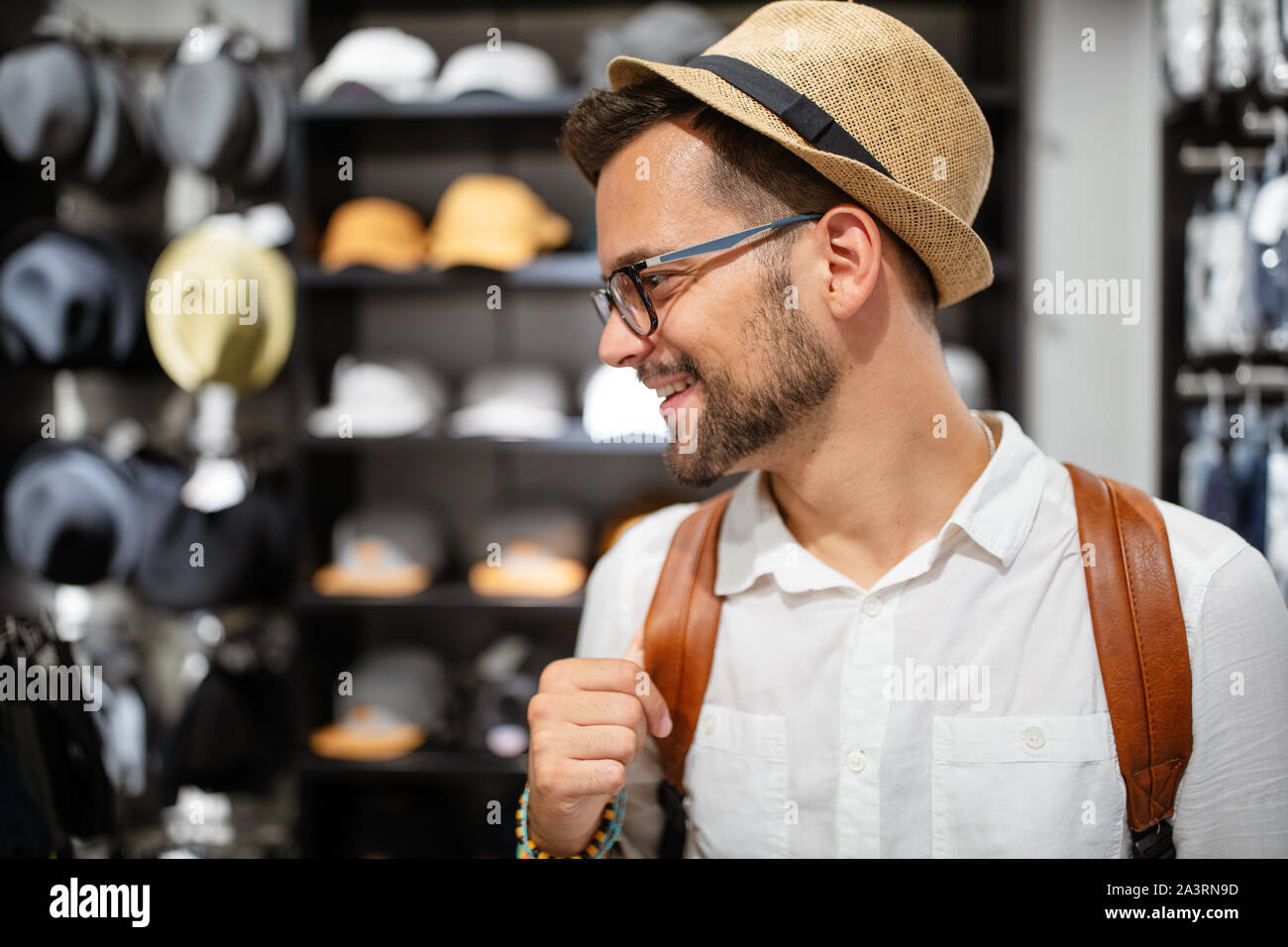 Handsome man shopping for new clothes in store Stock Photo - Alamy