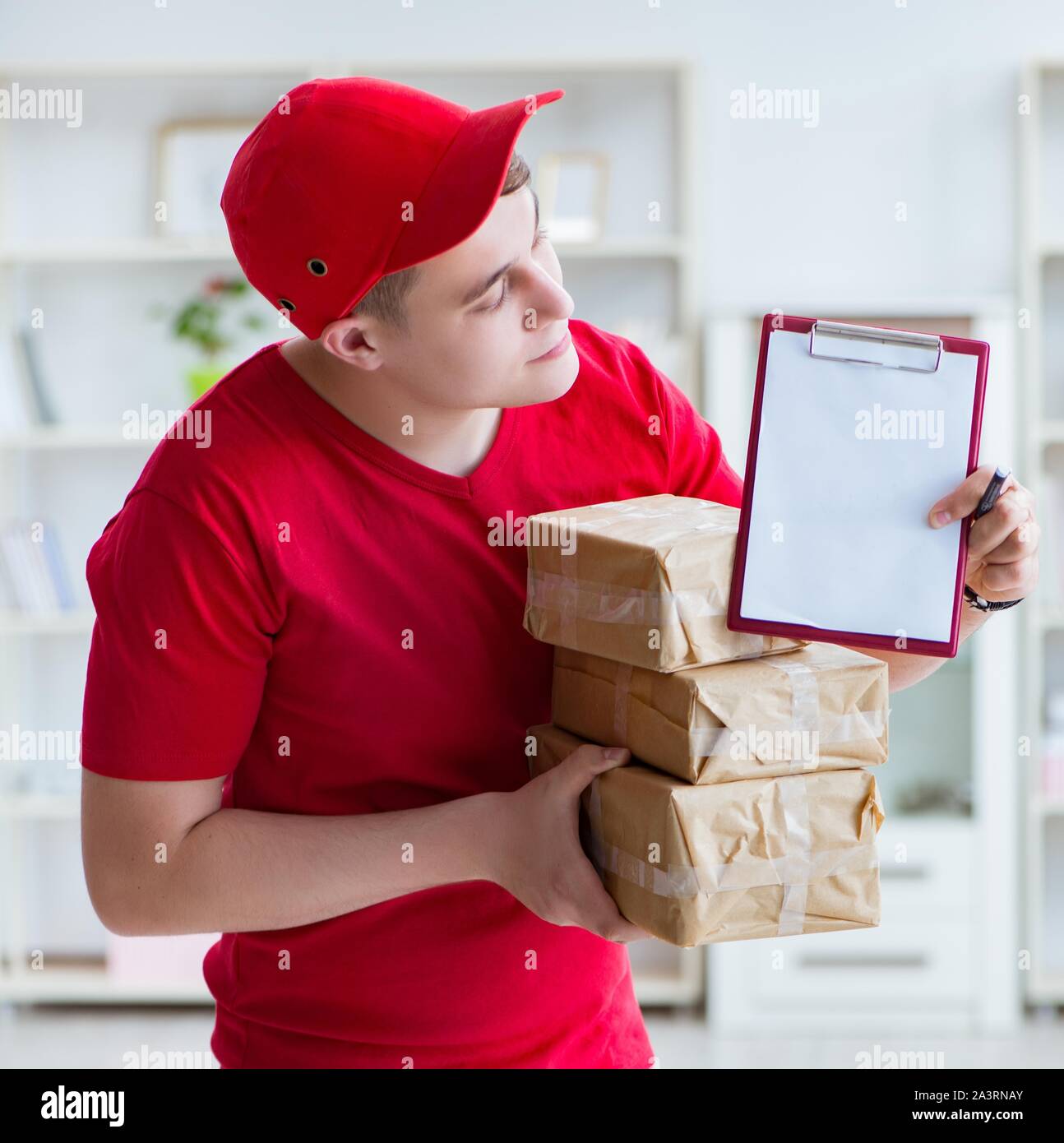 The post man delivering a parcel package Stock Photo - Alamy
