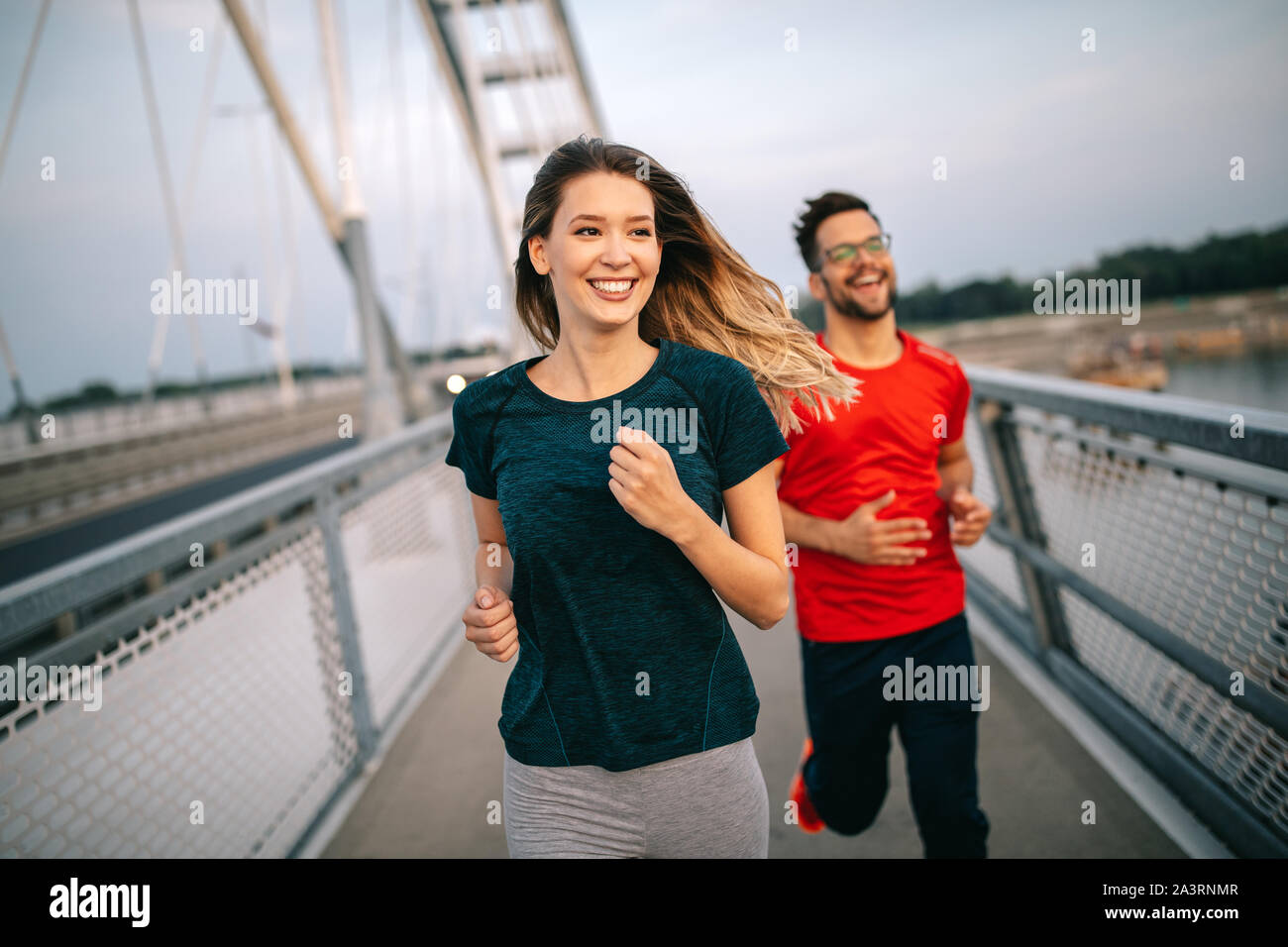 Beautiful couple running in nature living healthy Stock Photo - Alamy