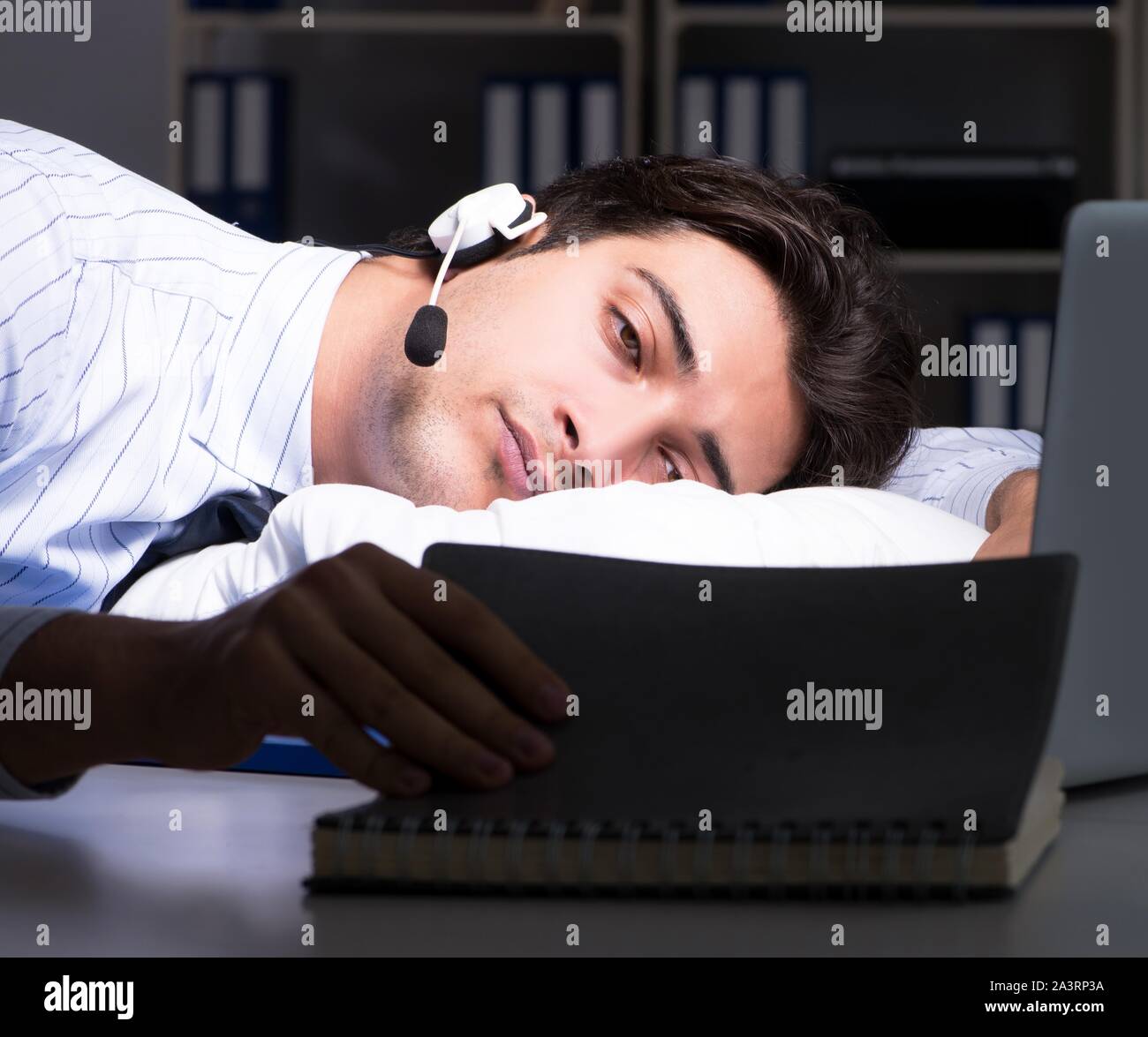 The tired and exhausted helpdesk operator during night shift Stock ...