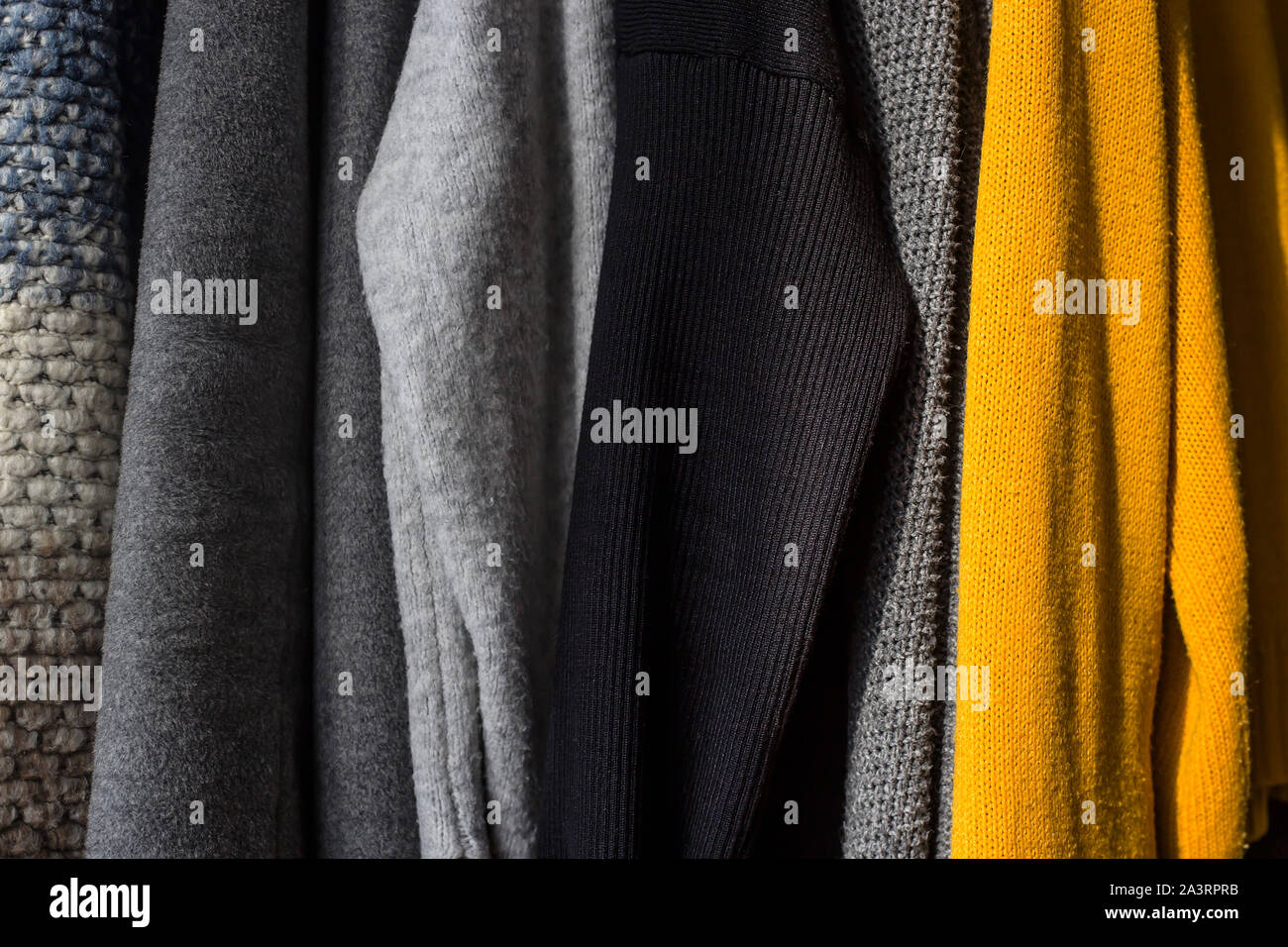 Woman hanging up coat hi-res stock photography and images - Alamy