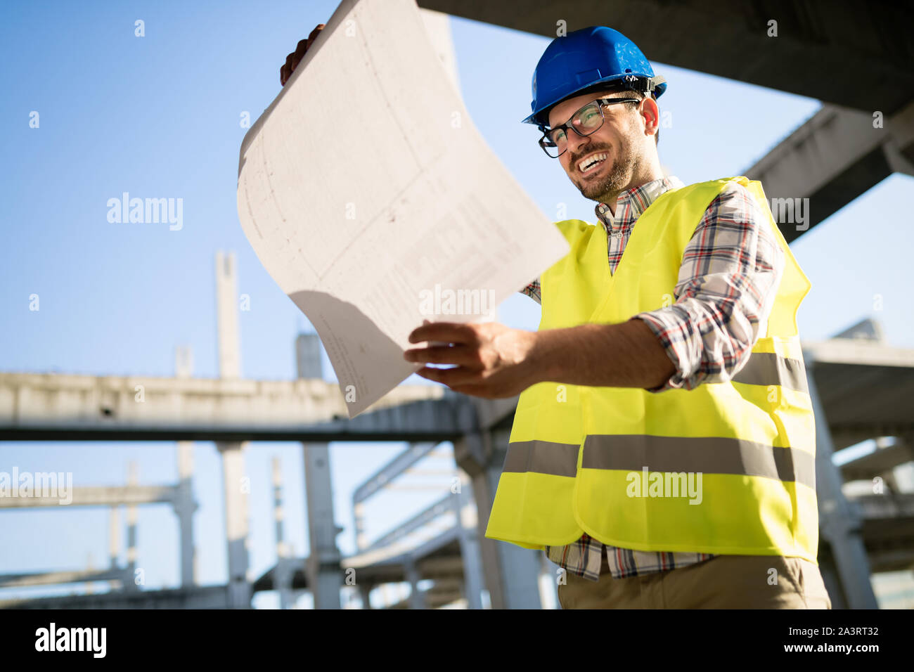 Picture of construction site engineer looking at plan Stock Photo - Alamy