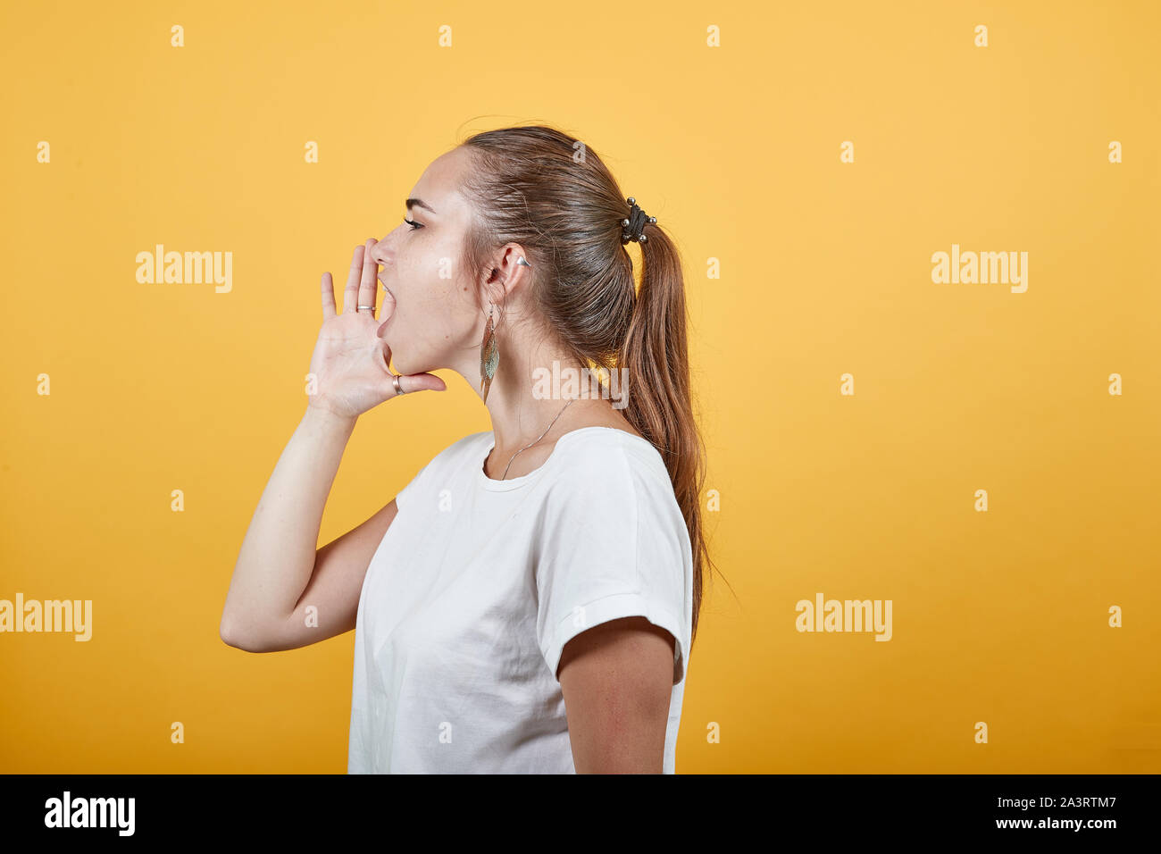 Beautiful girl shouting on someone Stock Photo - Alamy