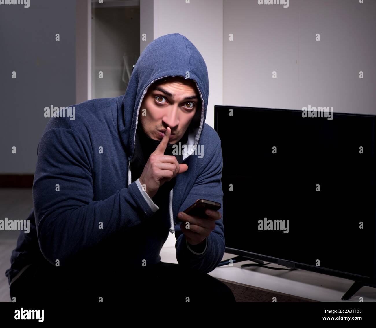 The burglar thief stealing tv from apartment house Stock Photo - Alamy
