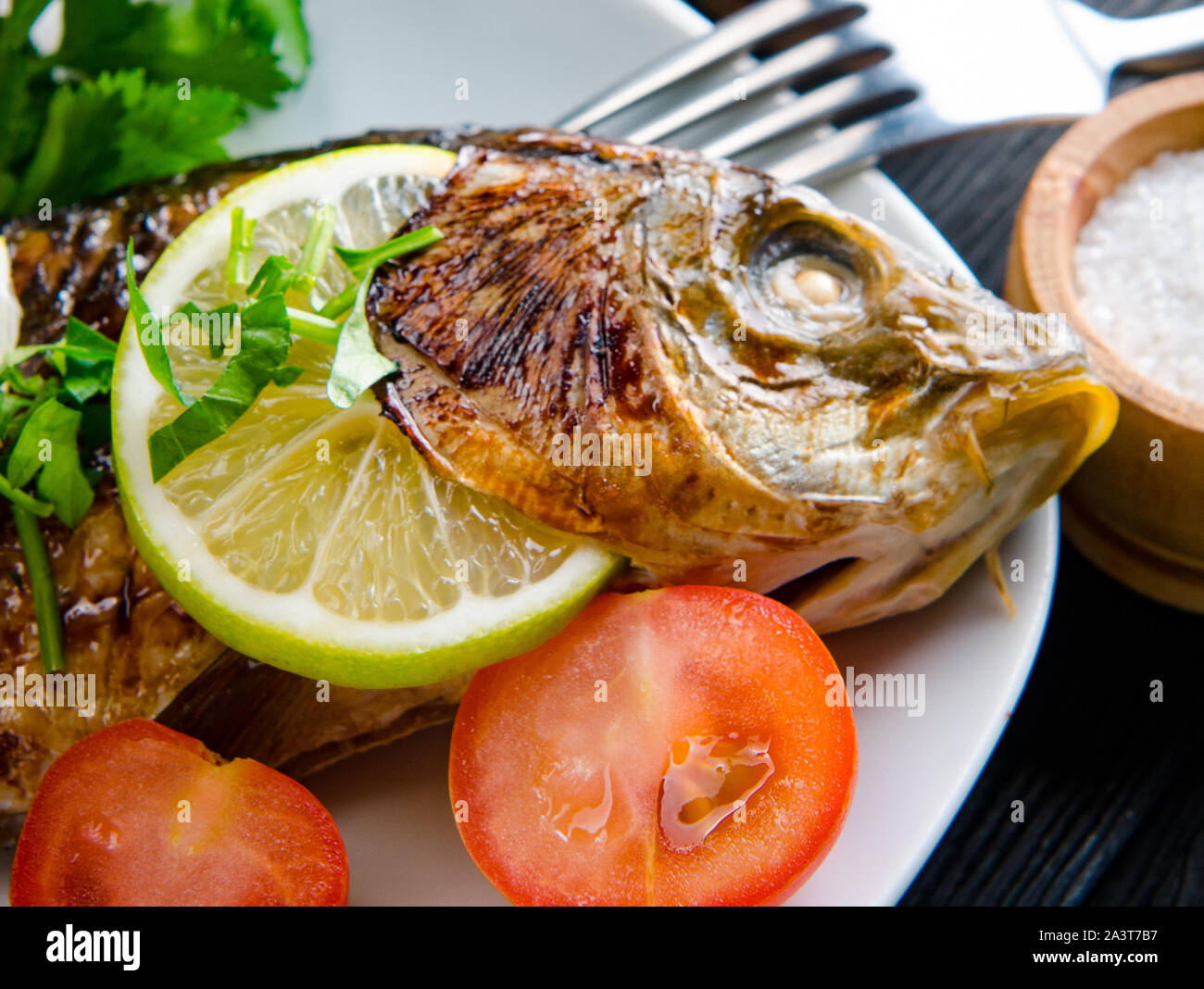 The fried fish served on the plate Stock Photo - Alamy